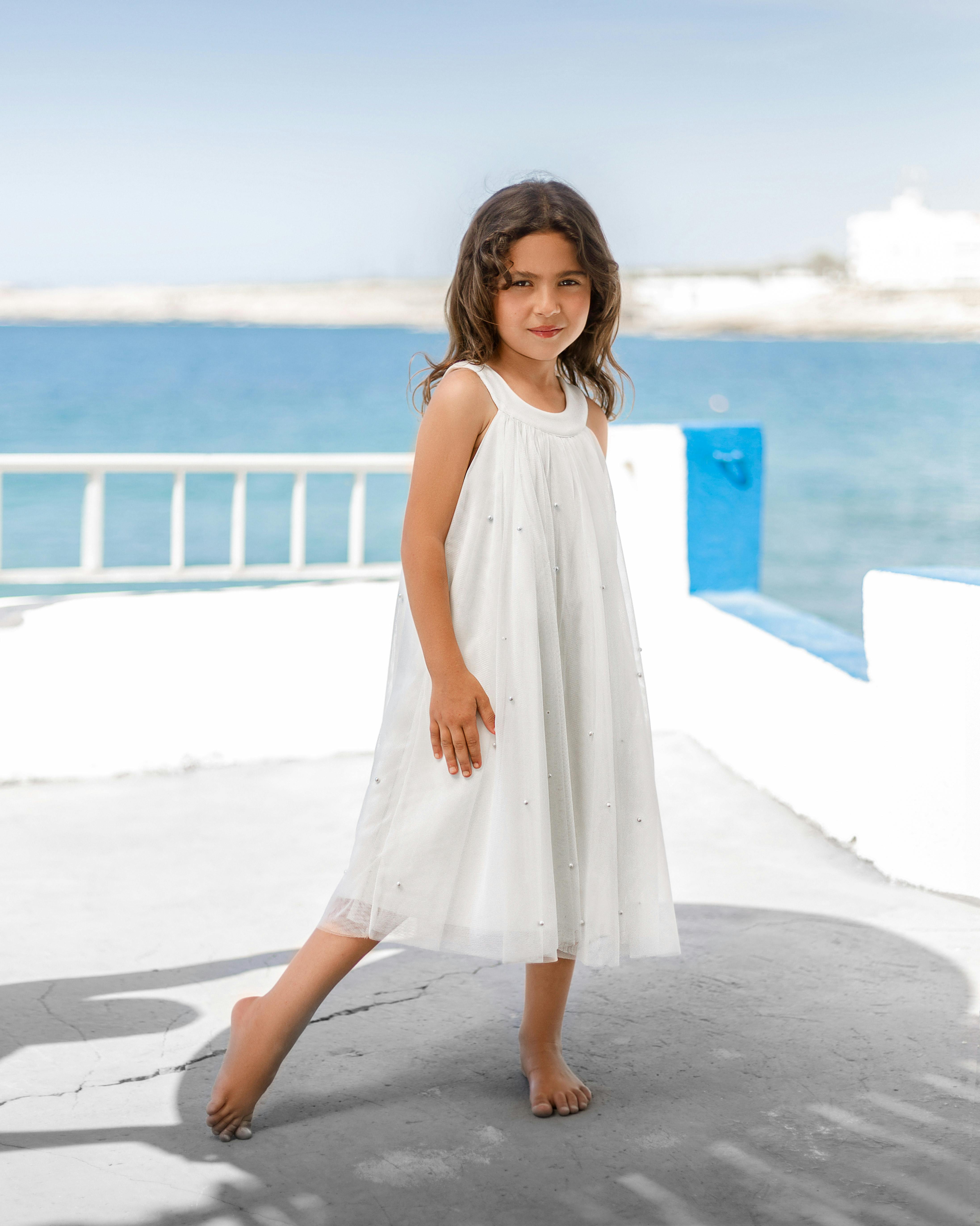 Barefoot Girl in White Dress by a Sea · Free Stock Photo
