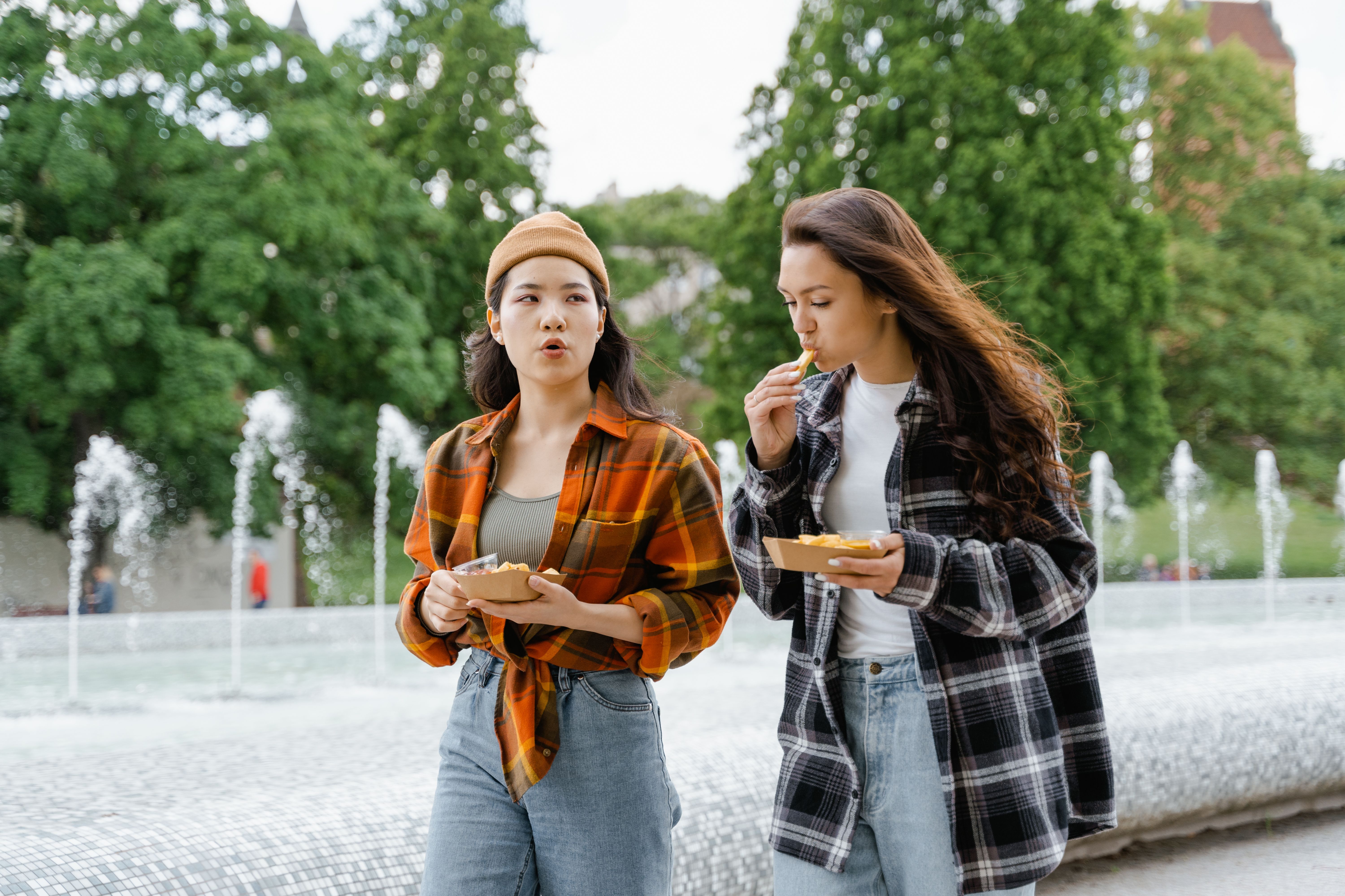 Women Eating while Walking at the Park · Free Stock Photo