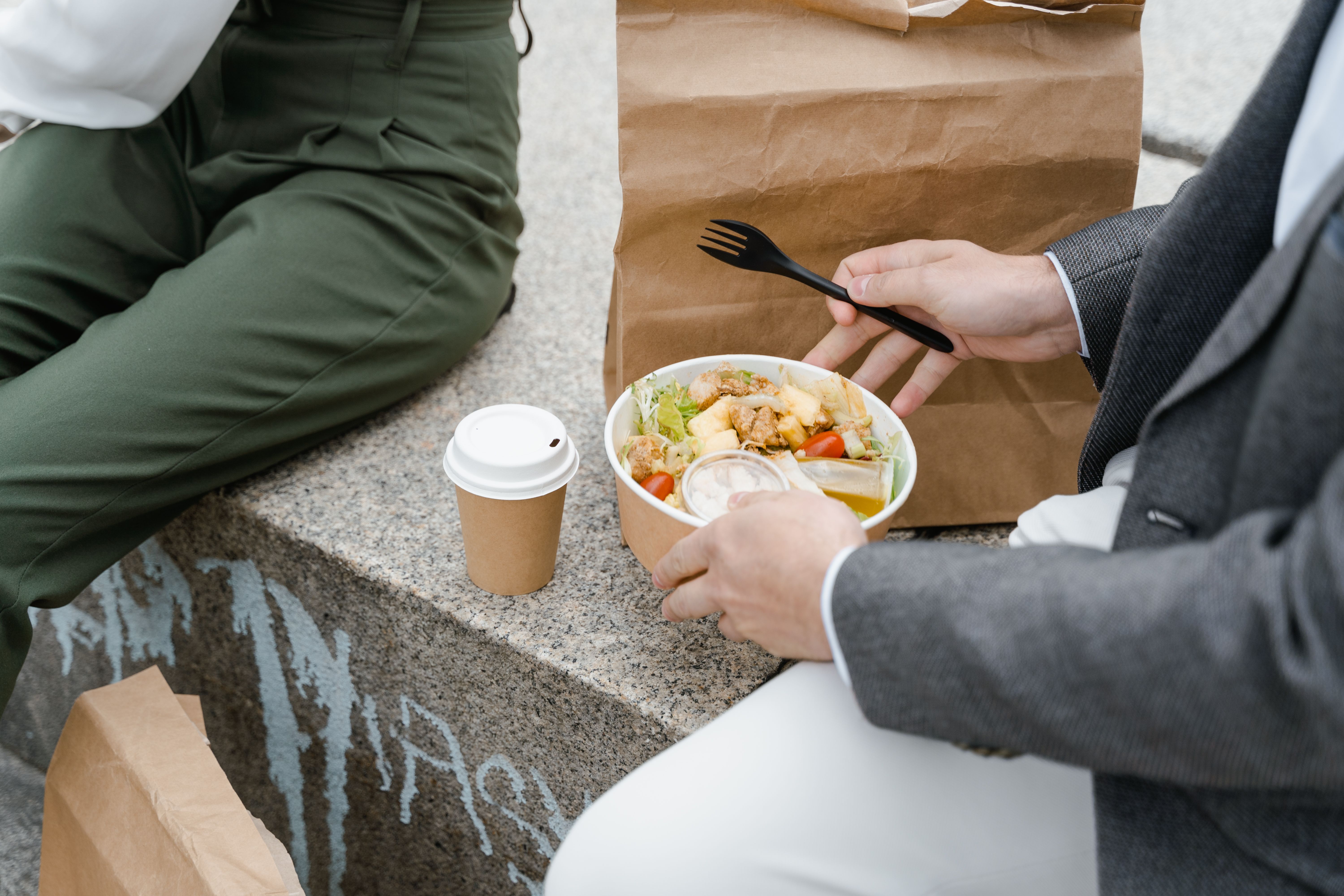 Person holding his Meal on a Disposable Container · Free Stock Photo