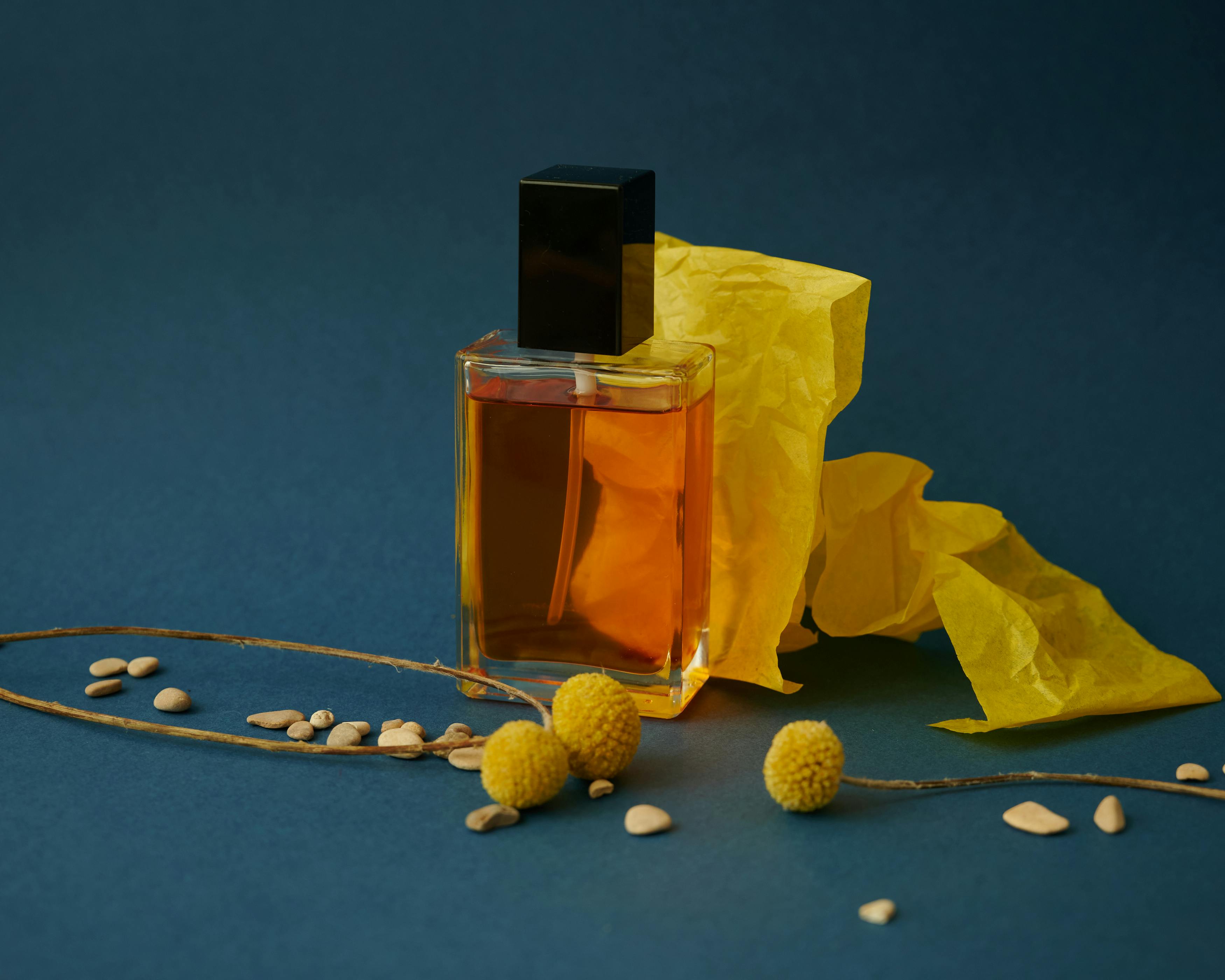 Brown Dried Leaf Beside Glass Perfume Bottle · Free Stock Photo