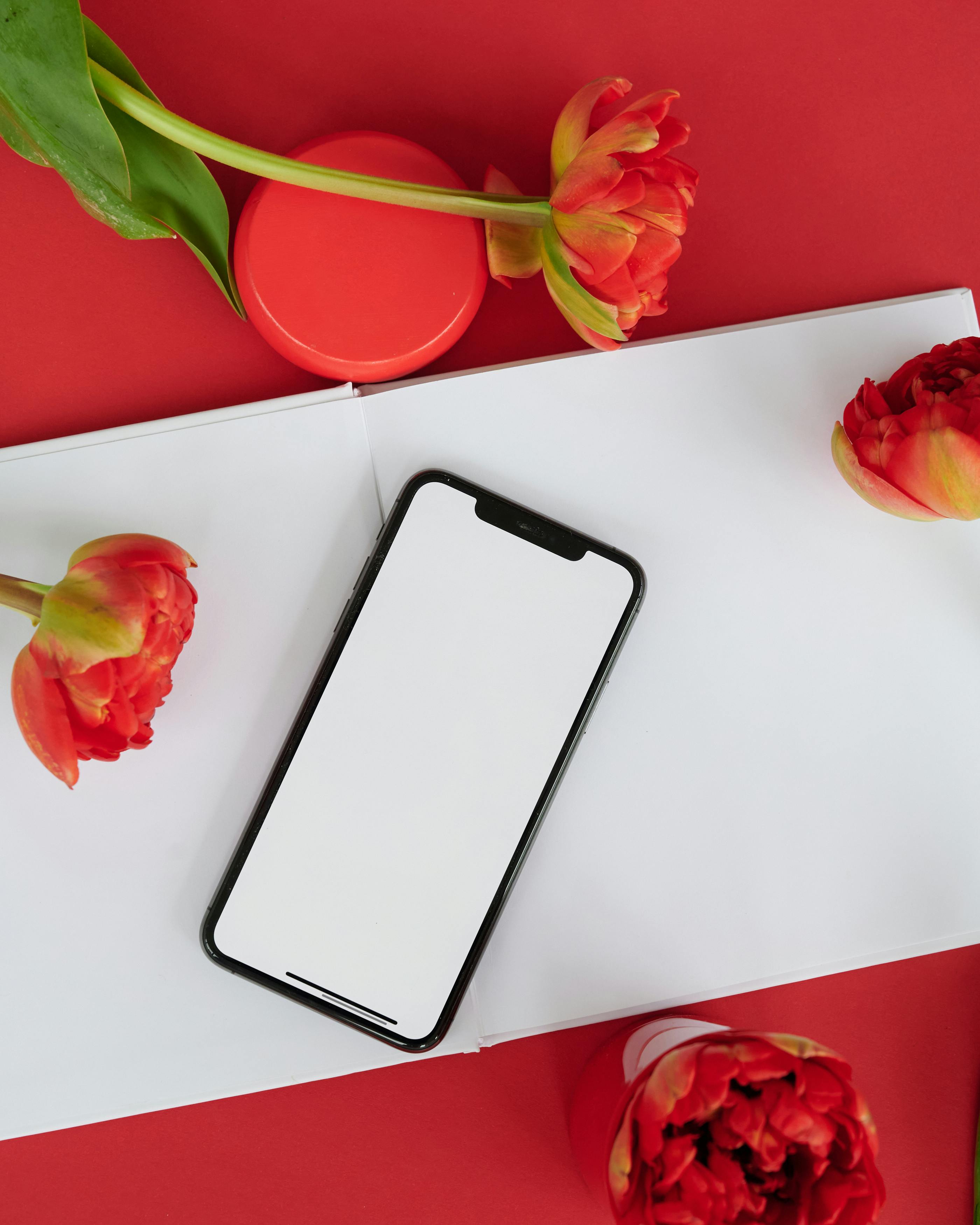 A Smartphone on the Top of a White Paper · Free Stock Photo