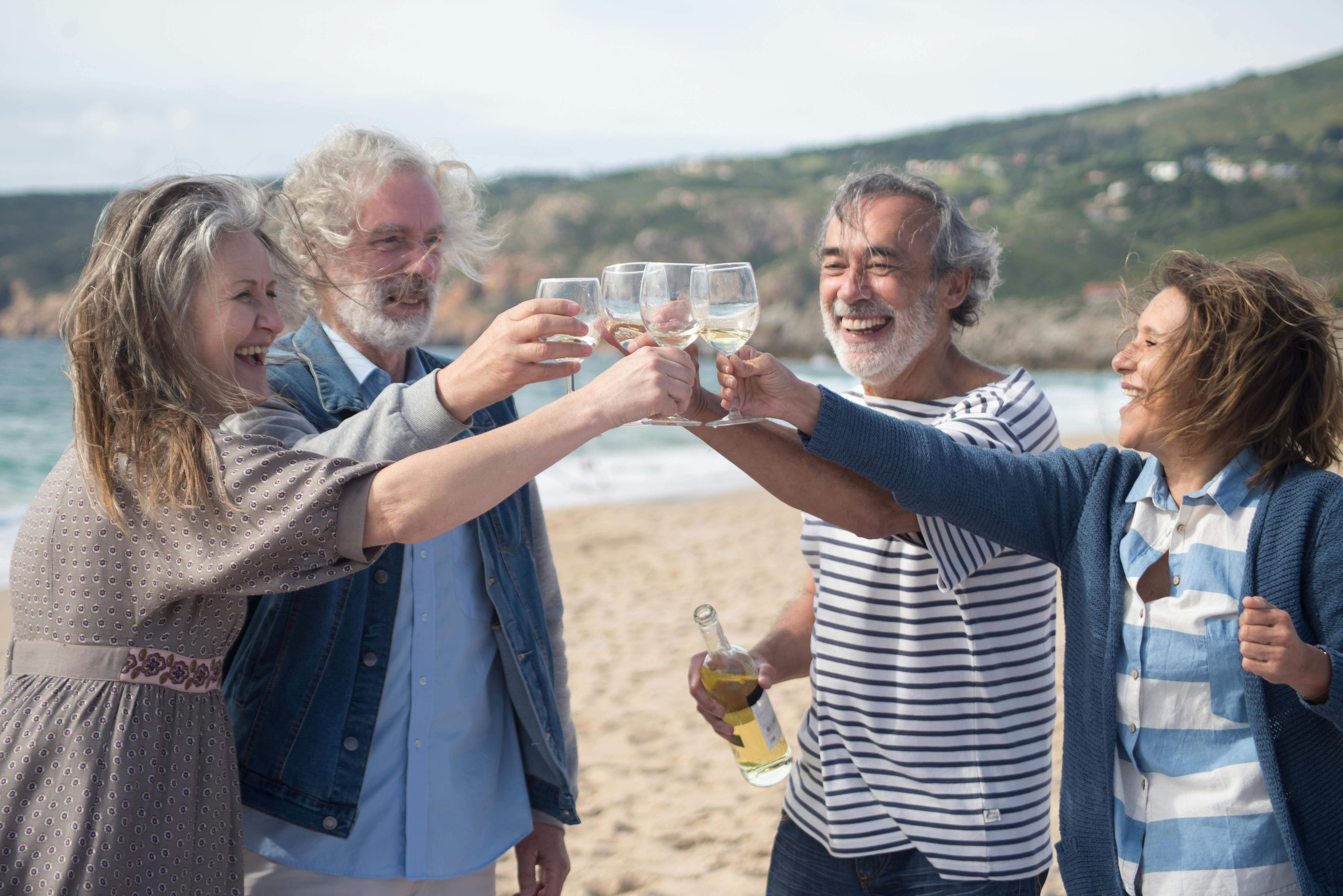 A People Cheers Together on the Beach · Free Stock Photo