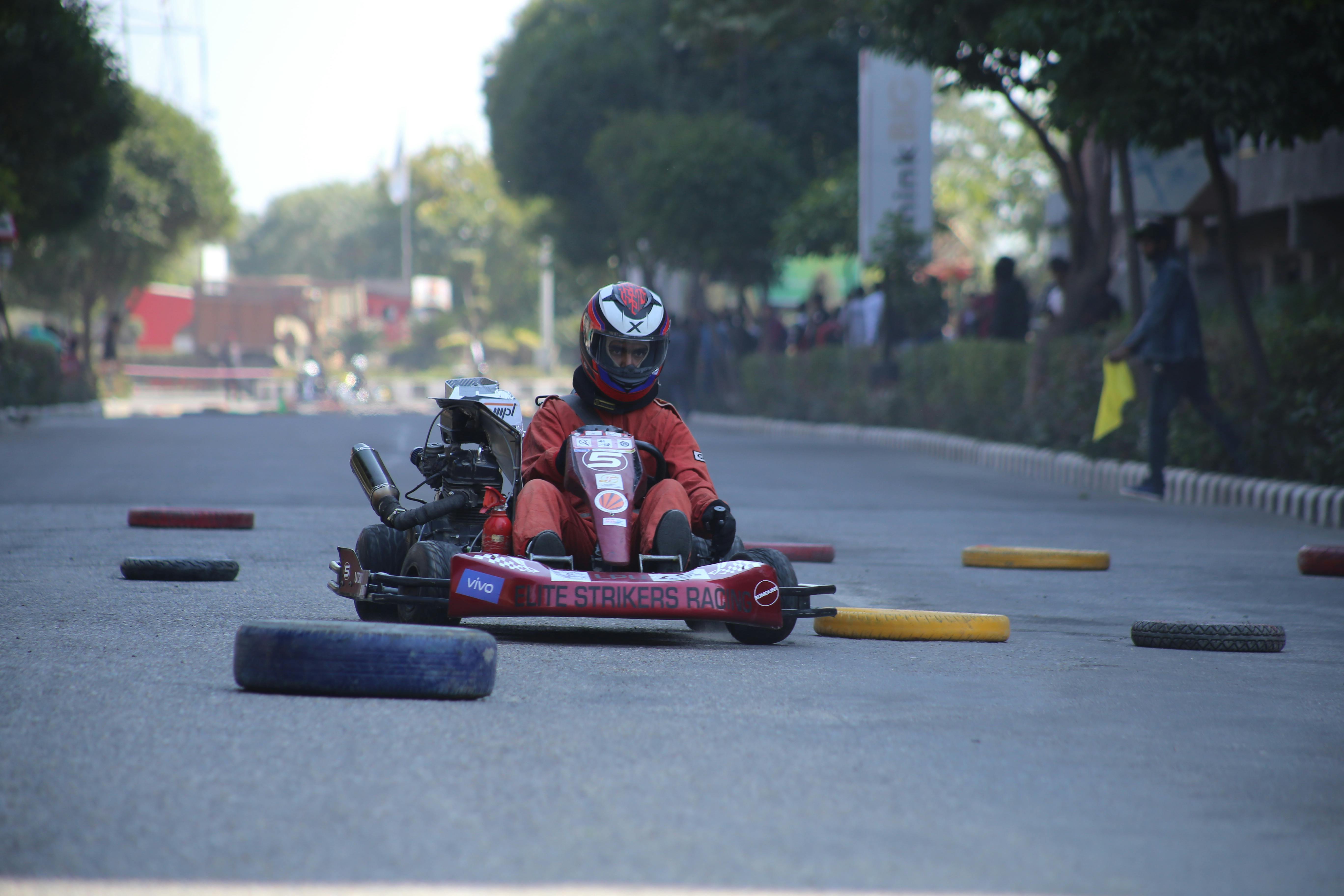 Person Riding Red Go Kart on a Racing Track · Free Stock Photo