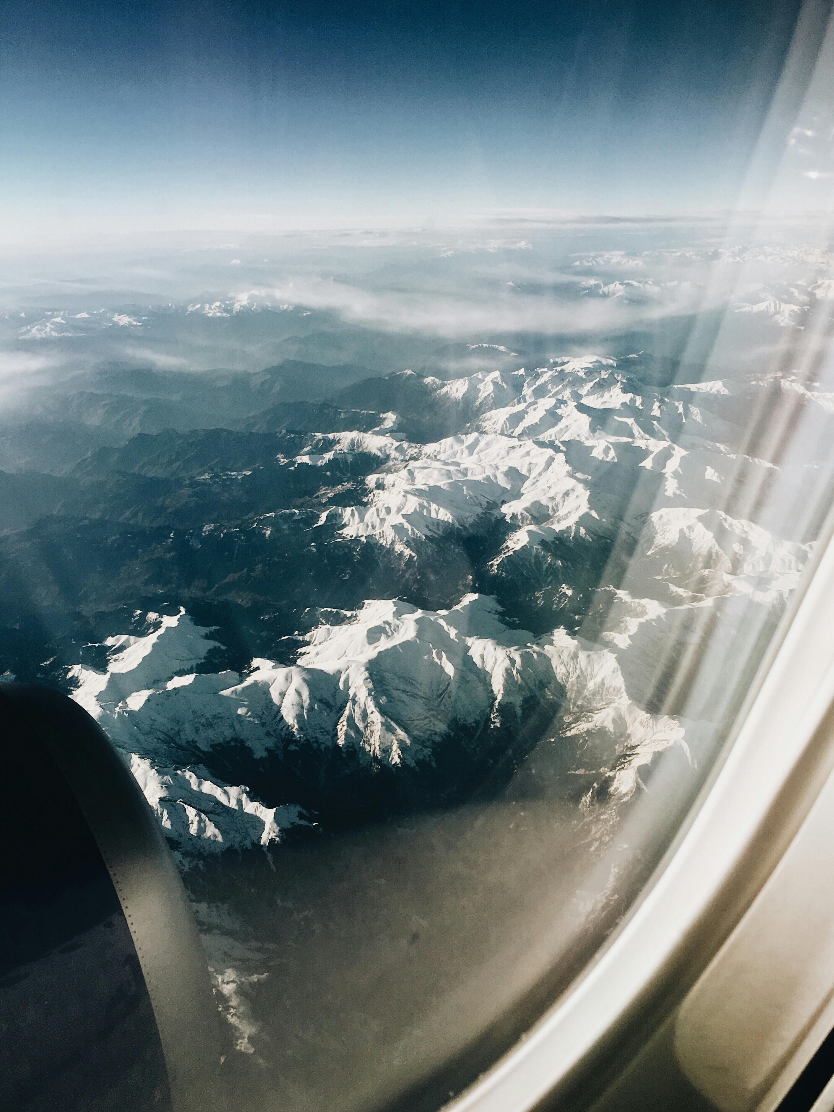 A View of Snow Capped Mountains from an Airplane · Free Stock Photo