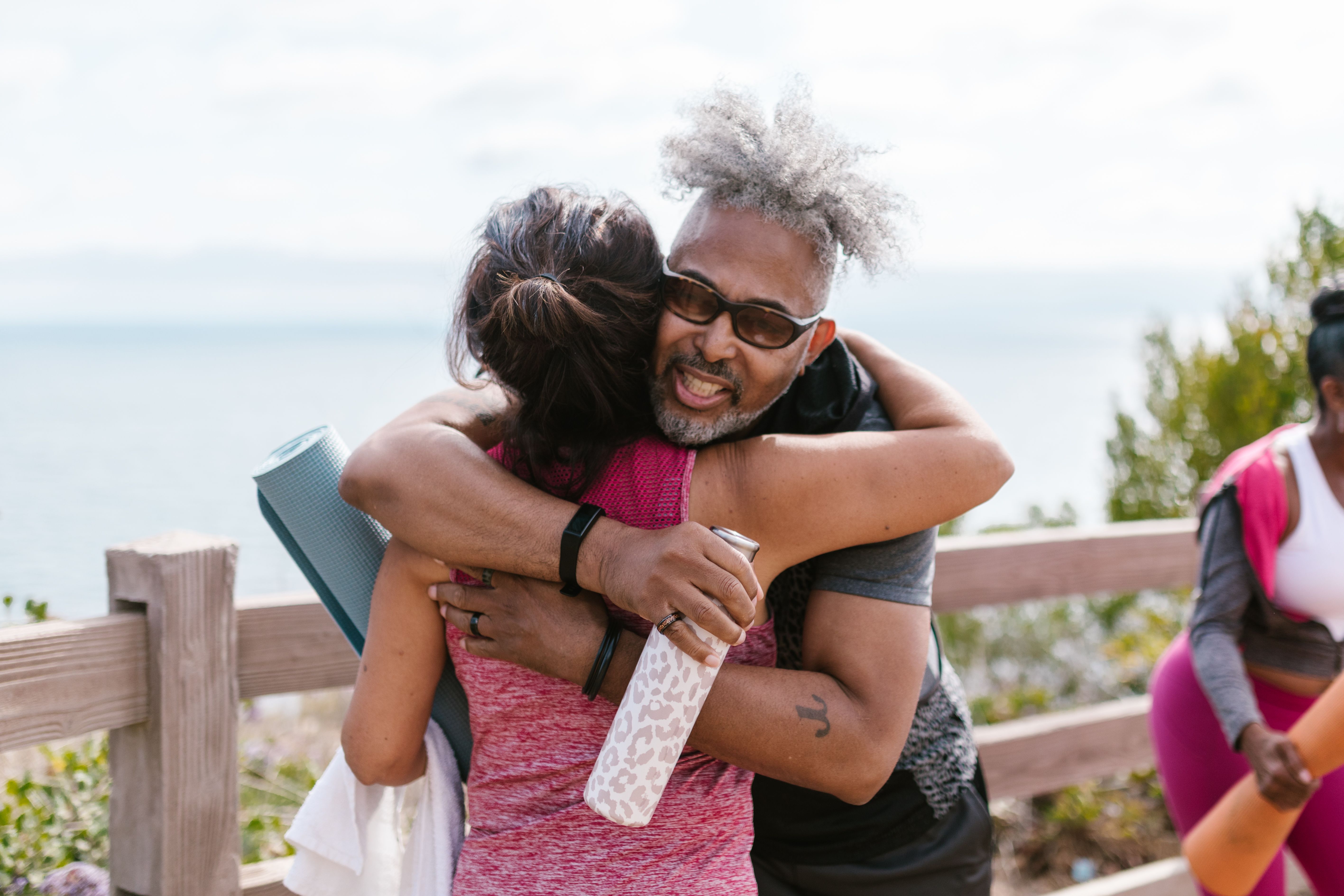 A Man in a Red Shirt Greeting Another Person · Free Stock Photo