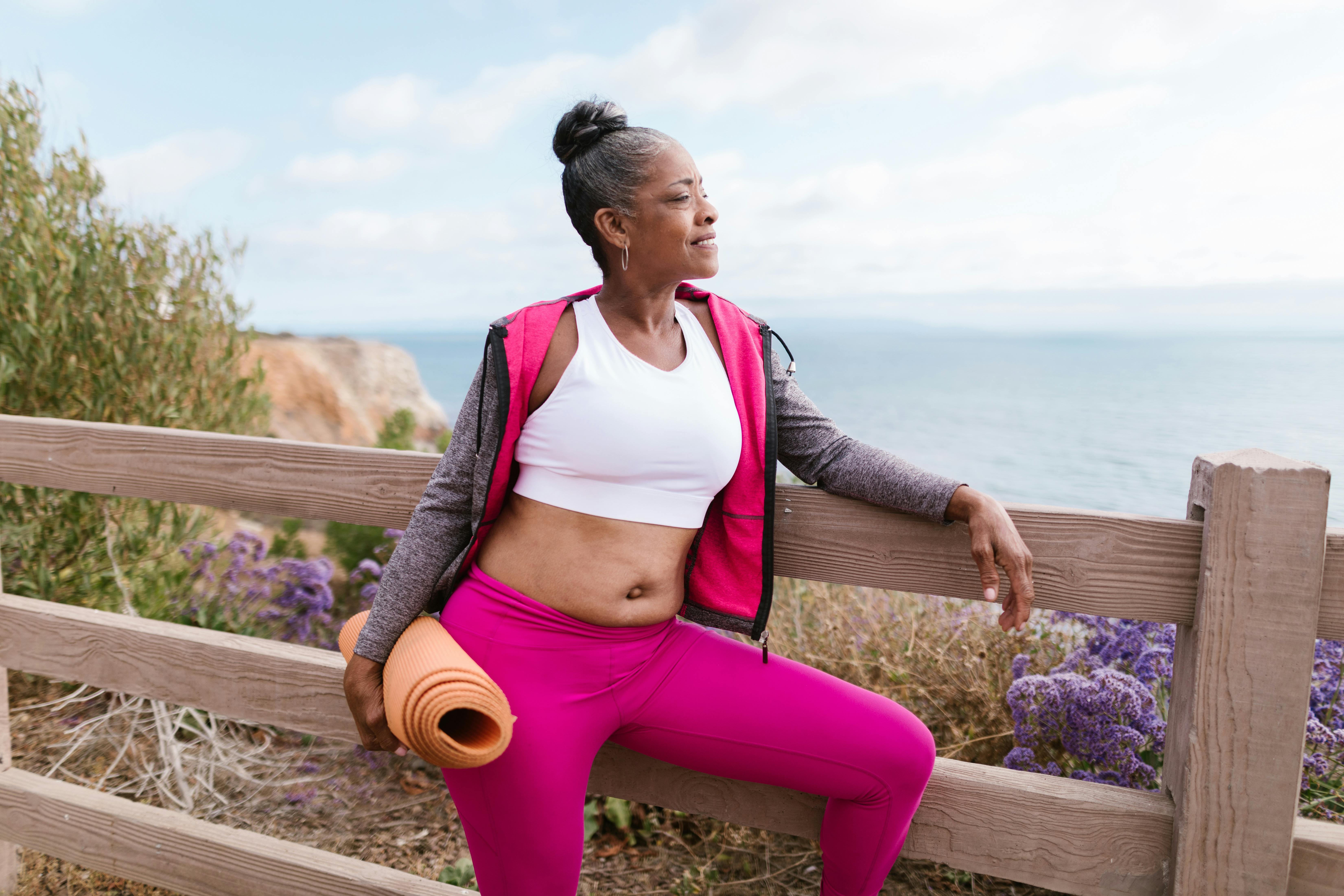 A Woman in a Red Robe Holding Books · Free Stock Photo