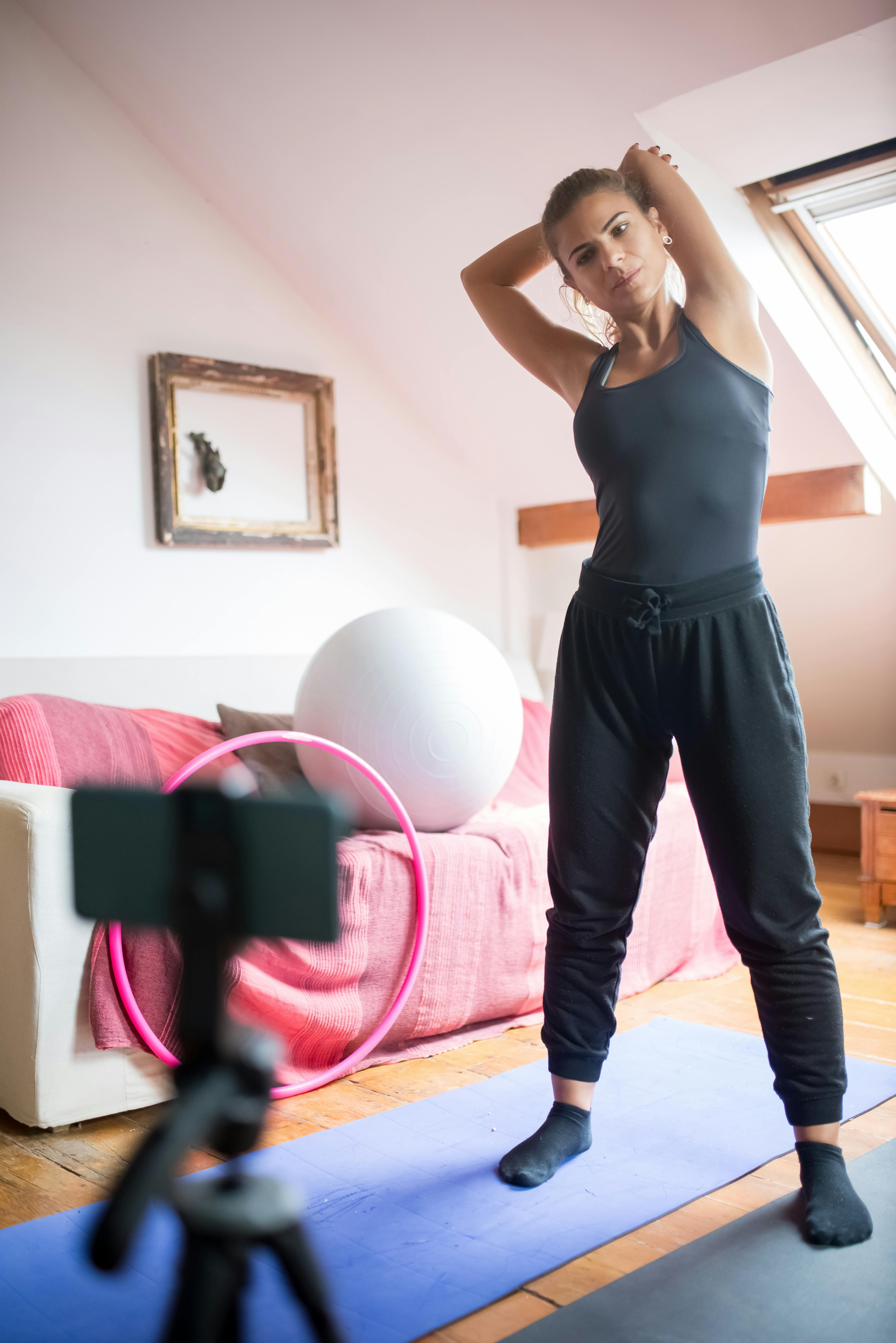 Trainer Recording Fitness Session · Free Stock Photo