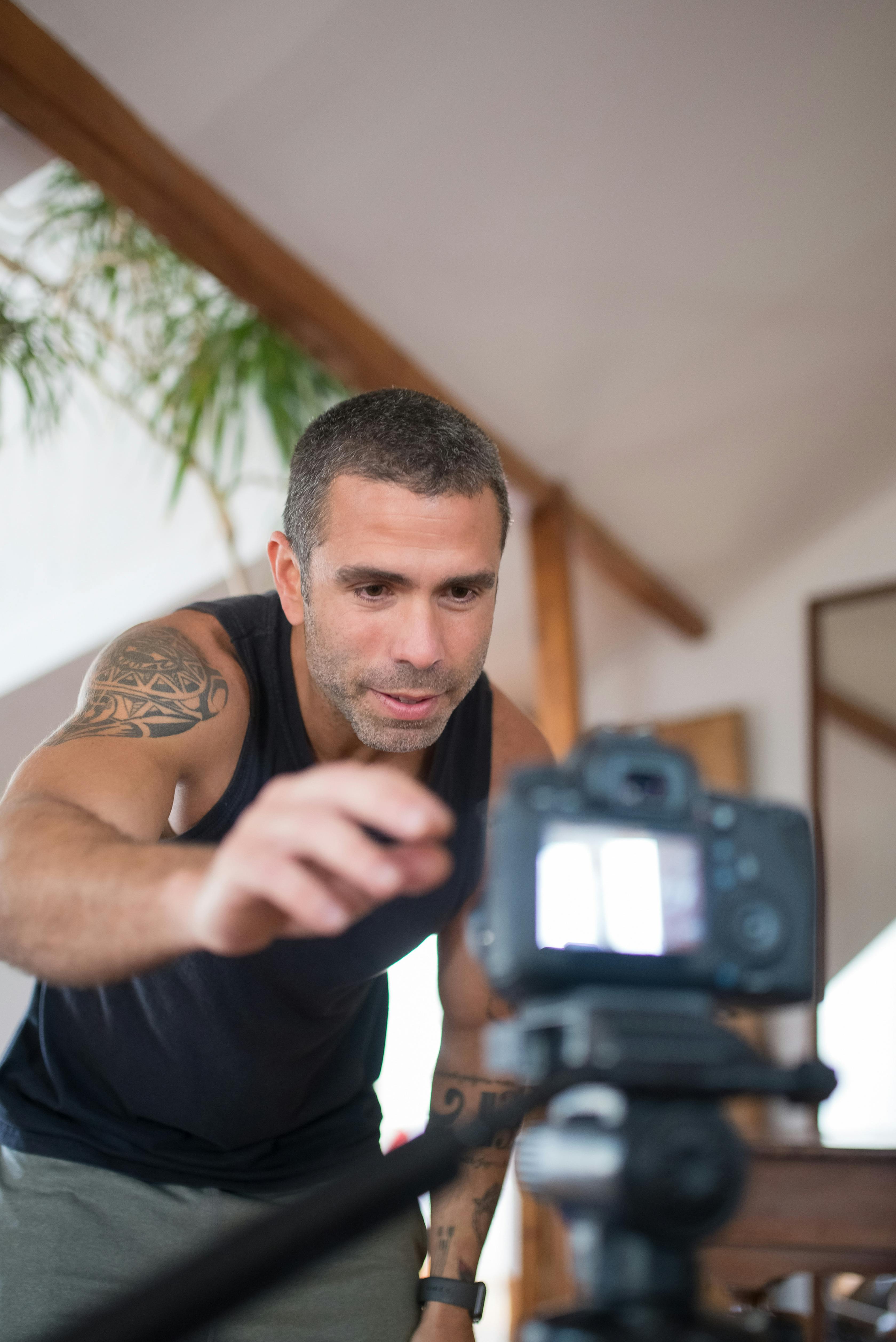 Man Using Camera on Tripod · Free Stock Photo