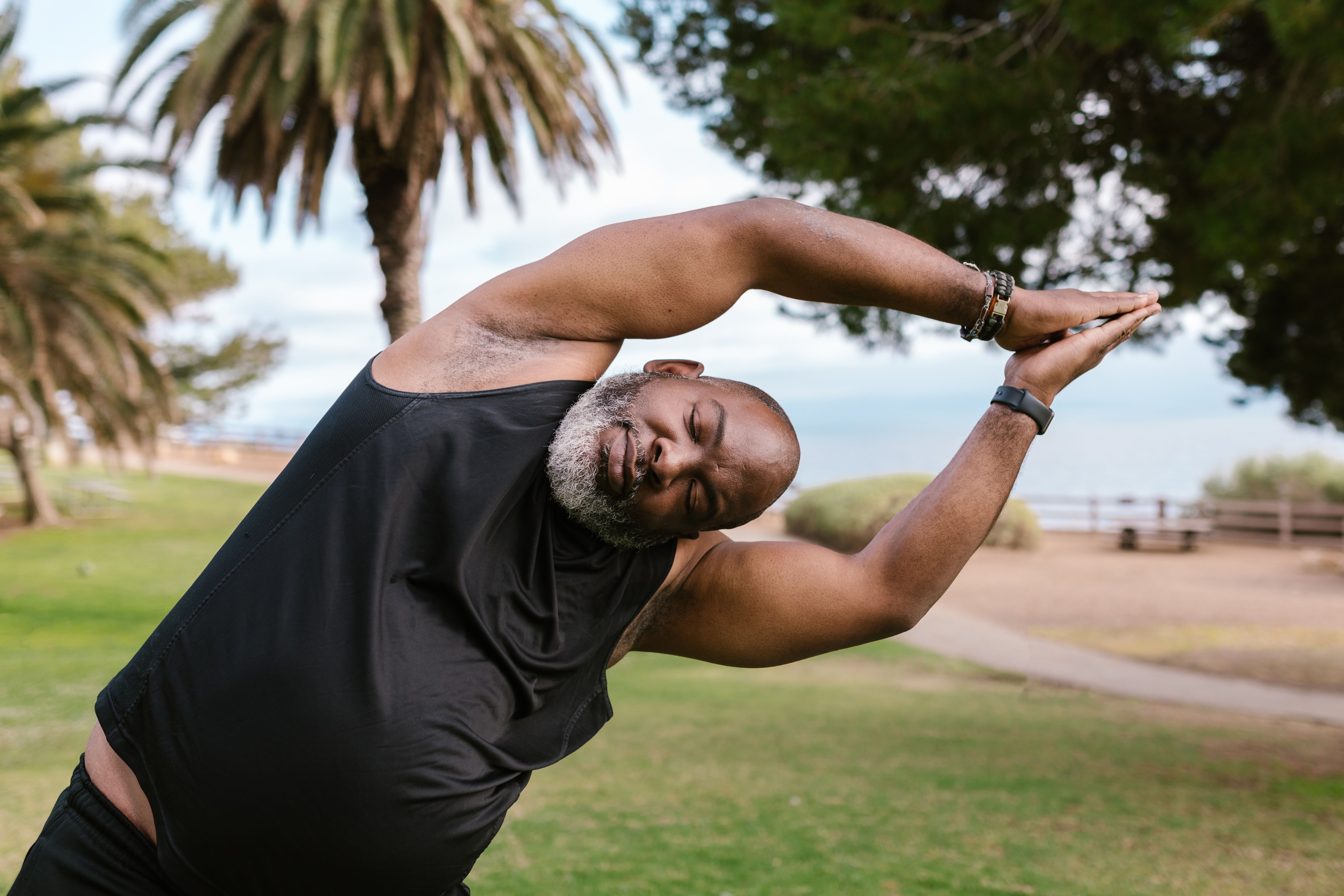 Man Seated Stretching with One Leg Extended · Free Stock Photo