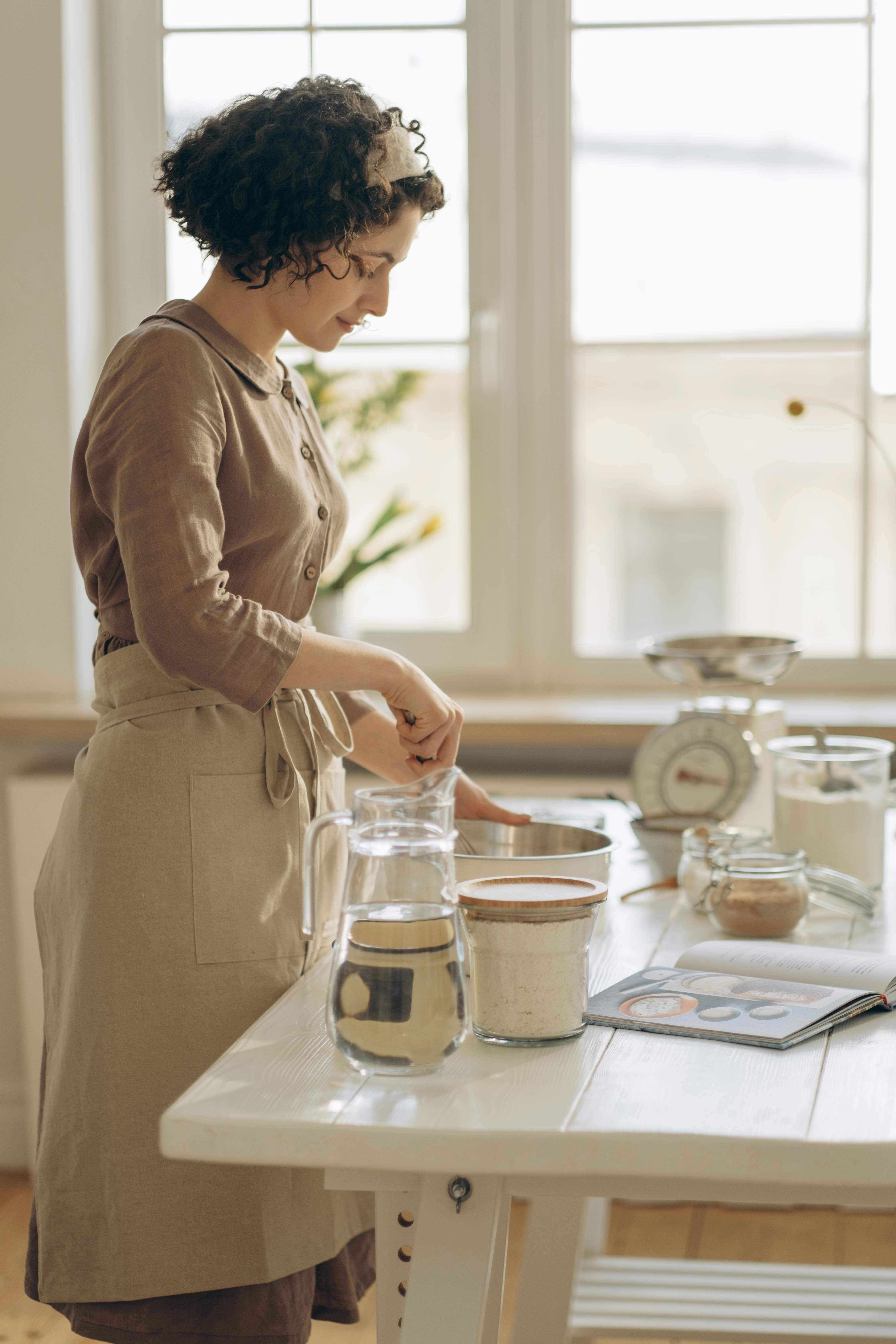 A Woman Cooking on the Table · Free Stock Photo