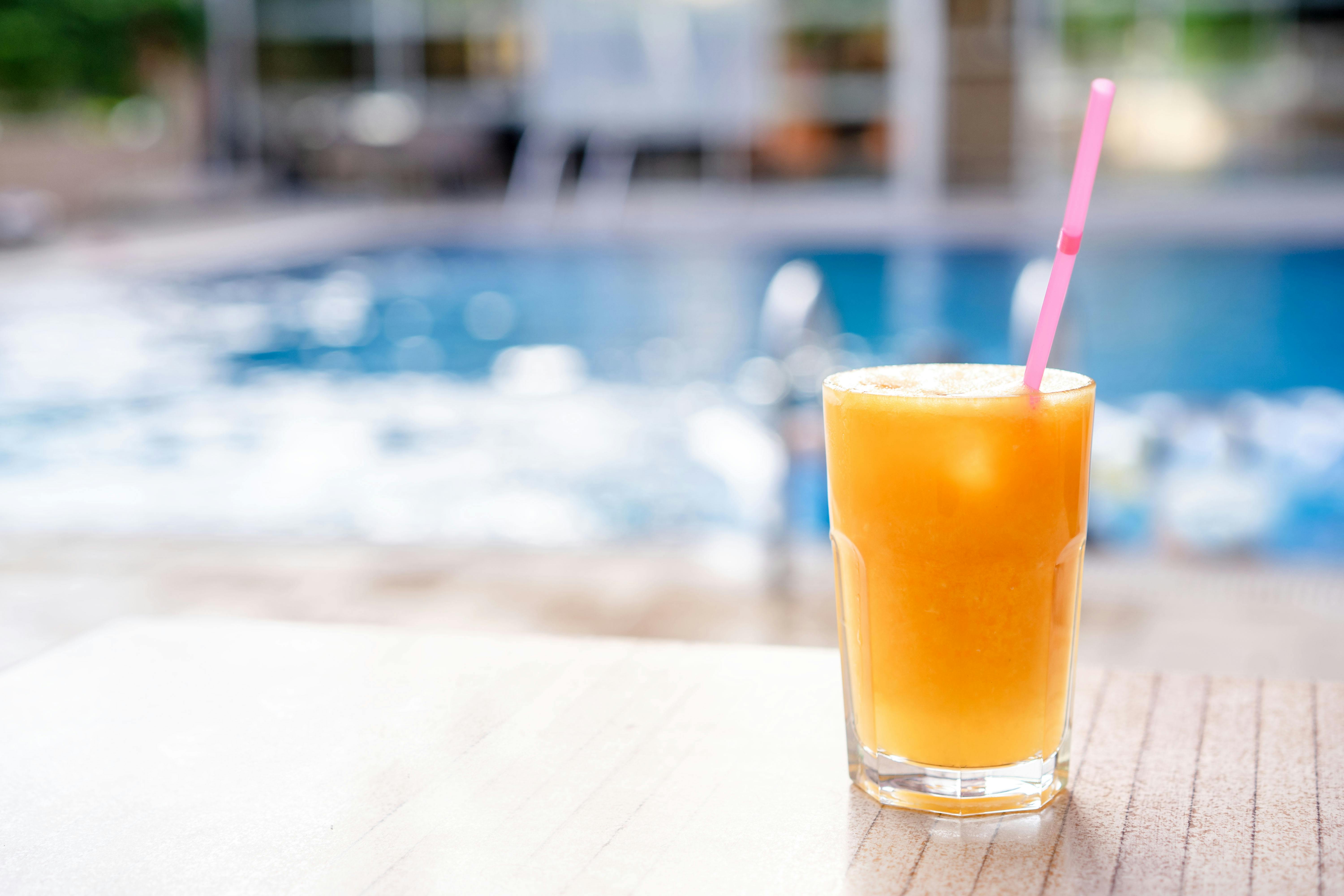 A Smoothie on the Table Near the Swimming Pool · Free Stock Photo
