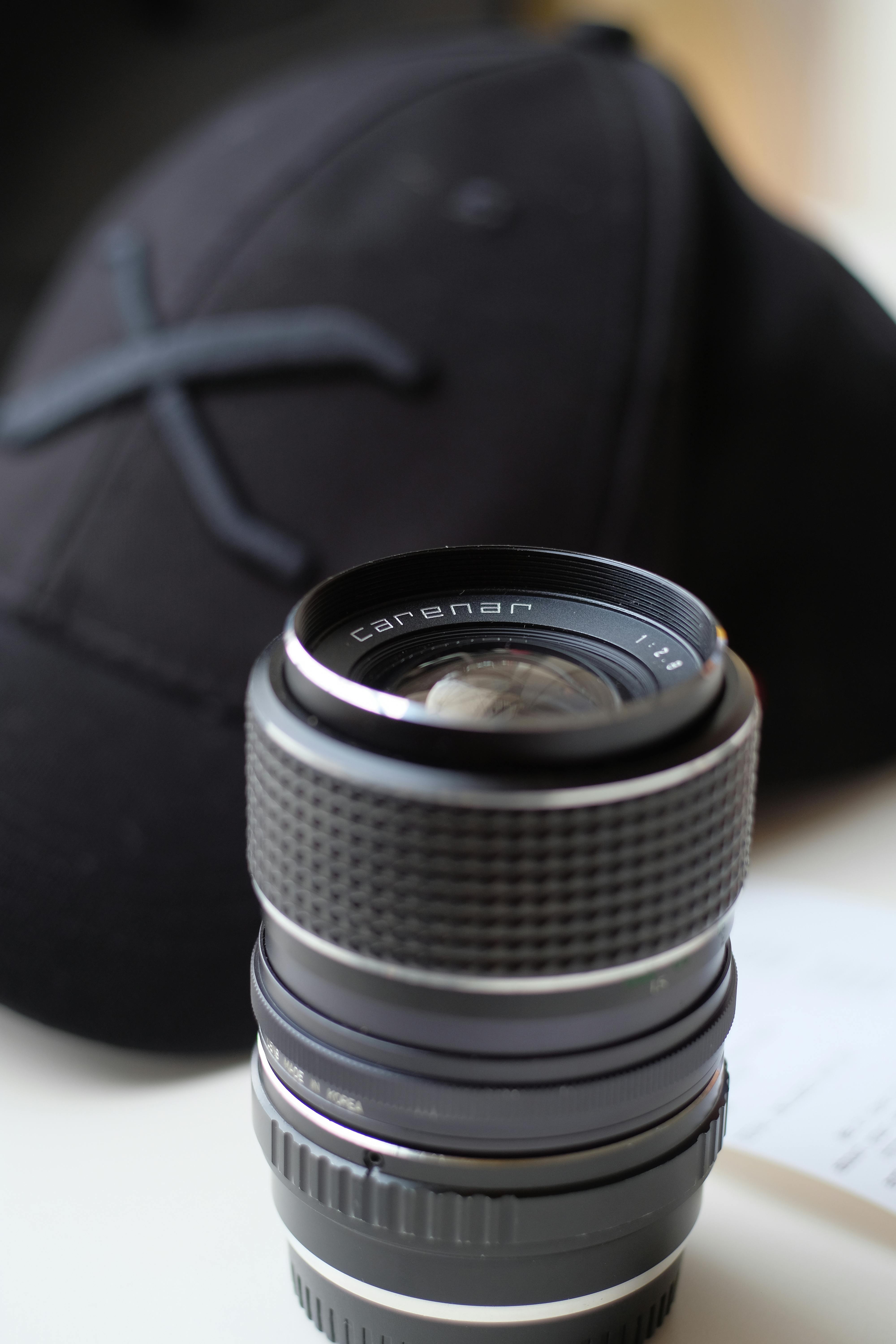 Person Holding a Camera Lens · Free Stock Photo