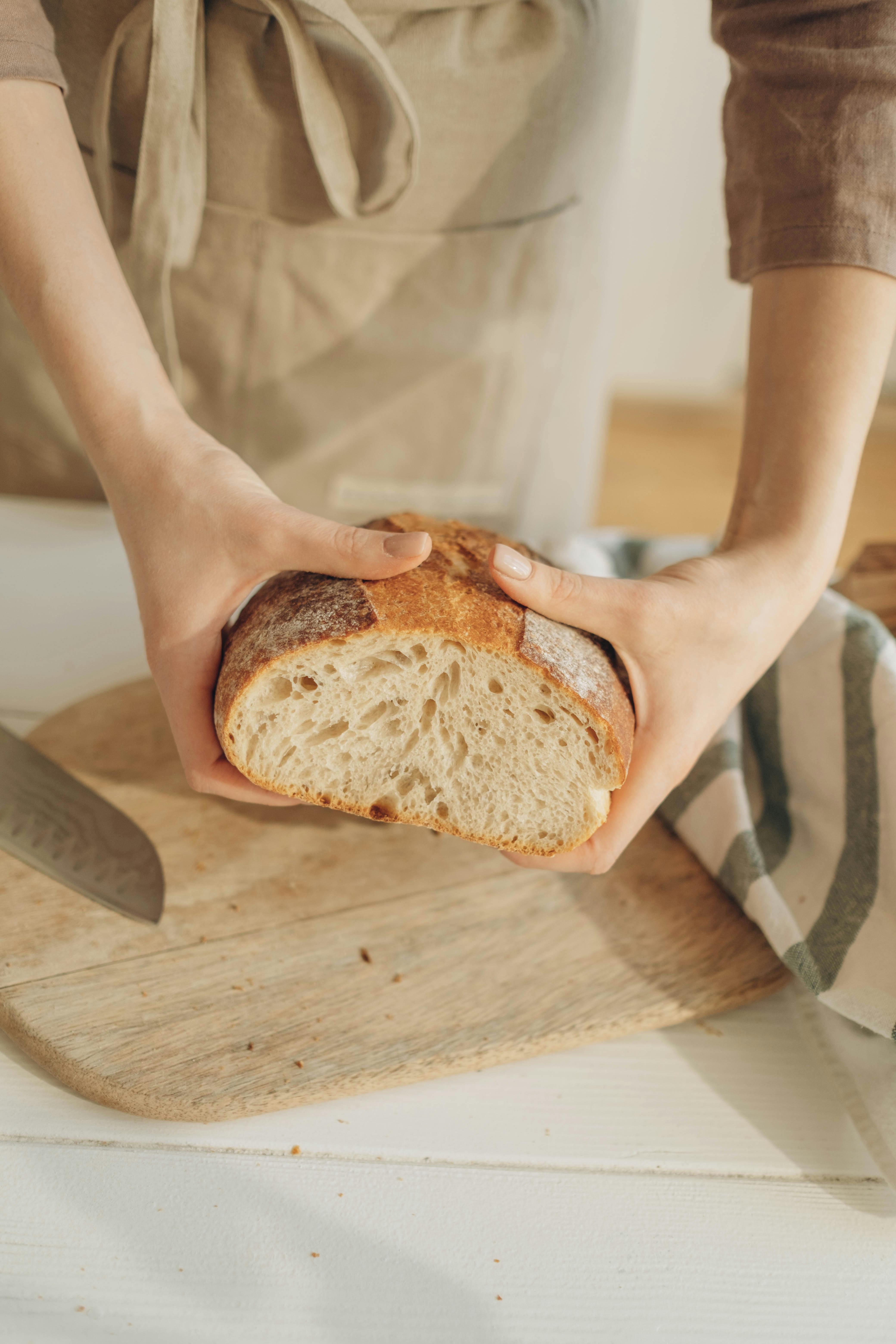 Person Holding Loaf of Bread · Free Stock Photo