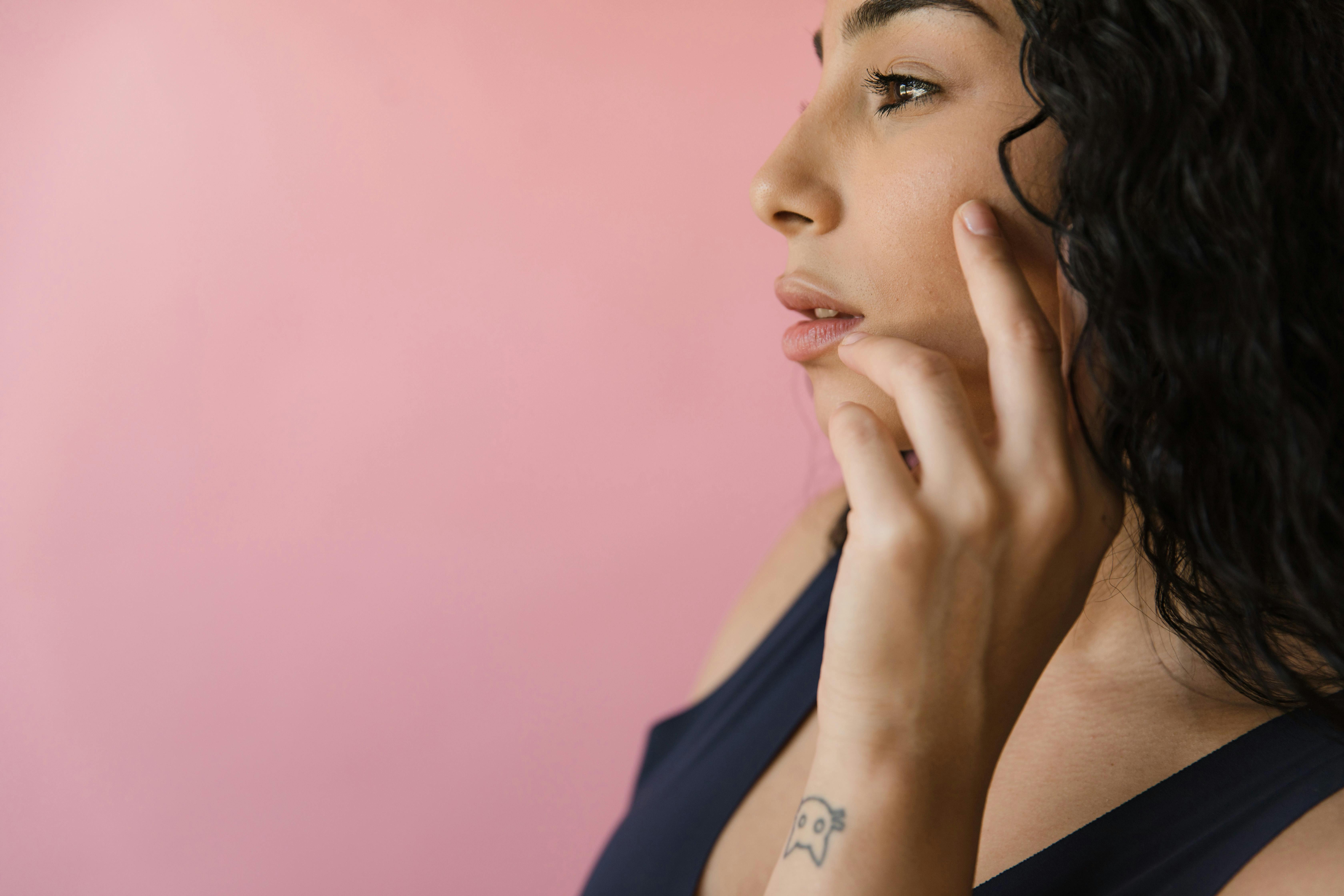 Close Up Photo of Woman with Her Hand on Her Face · Free Stock Photo