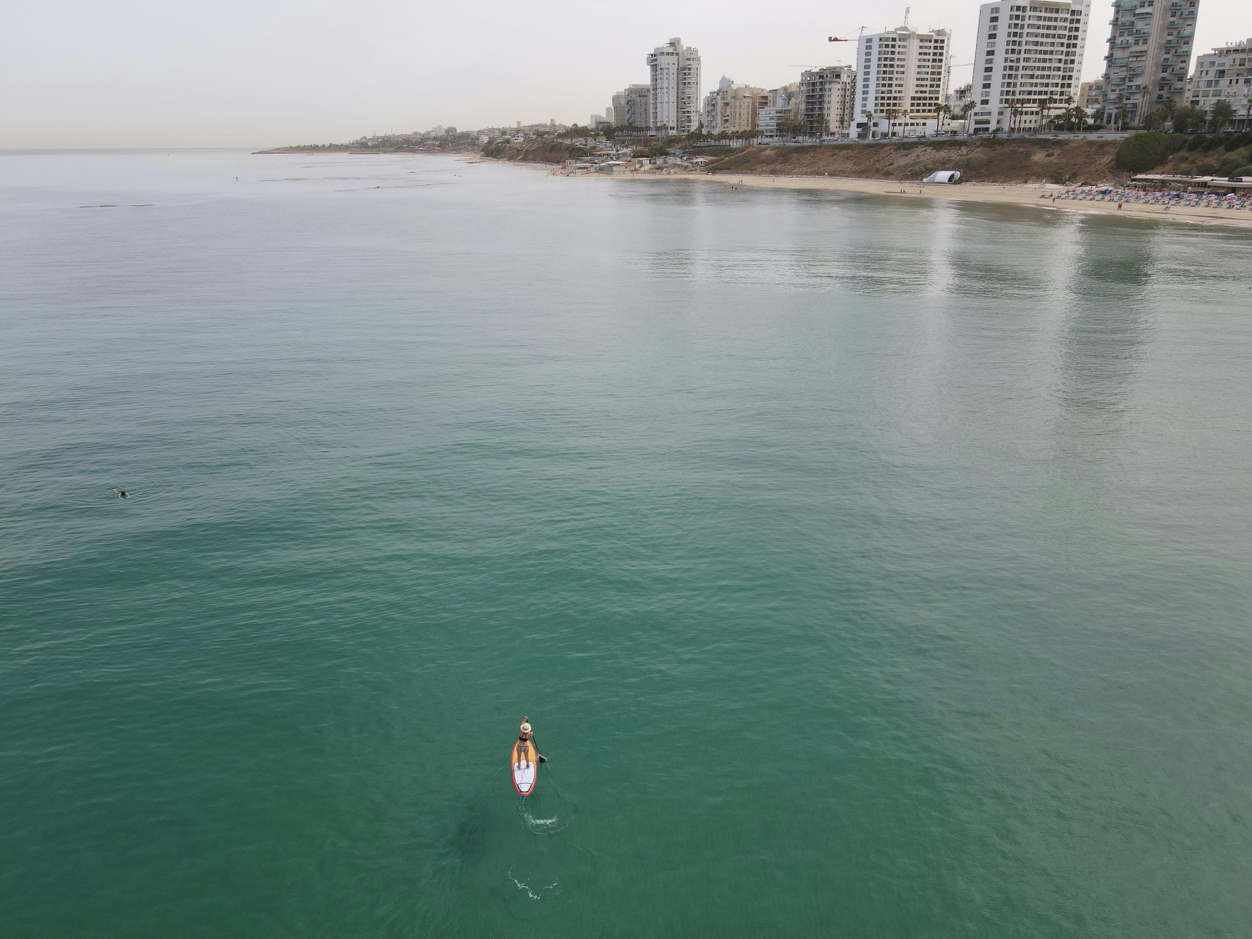 Top View of a Young Woman Lying in a Paddleboard on the Sea Surface ...
