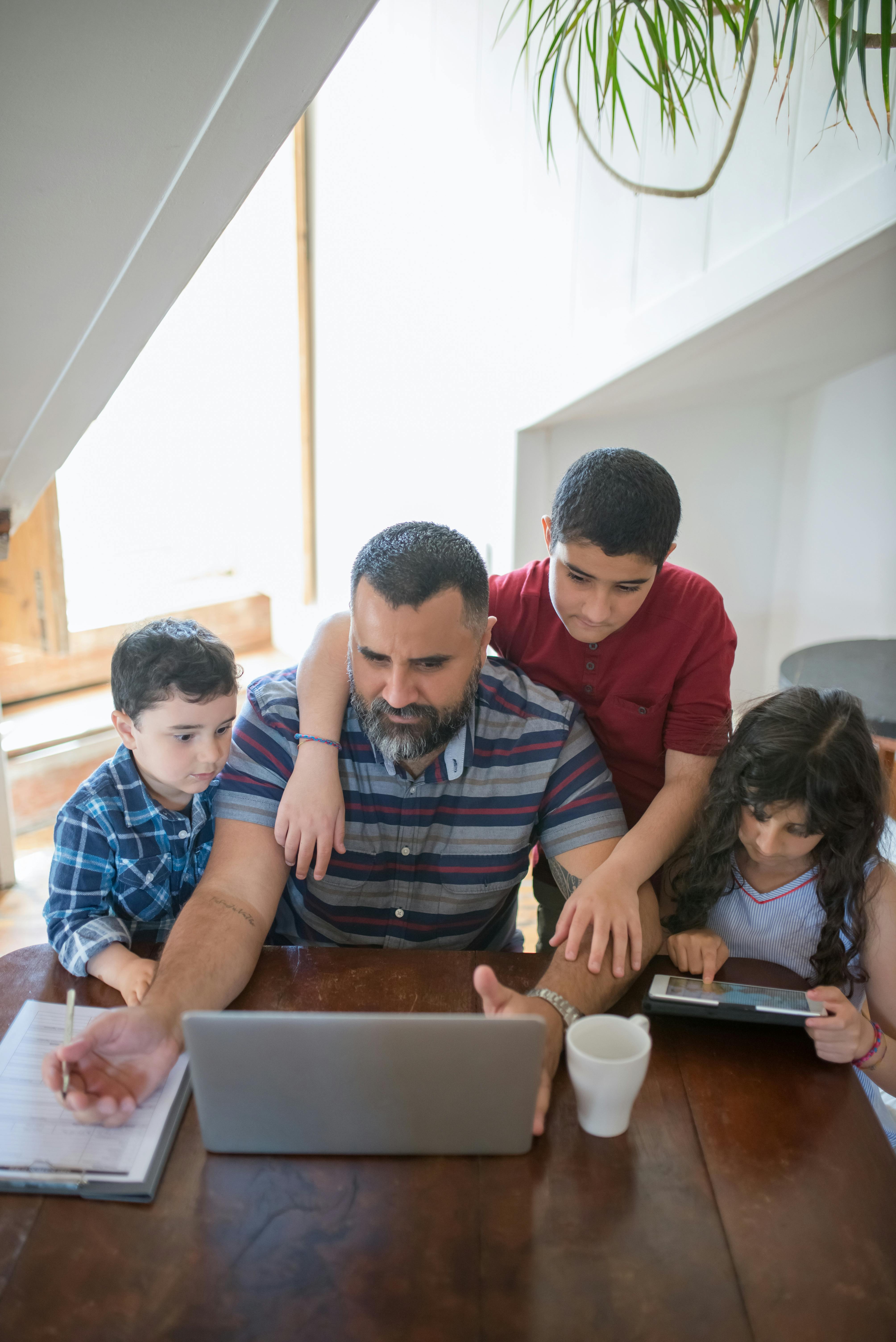A Family Sitting at the Table · Free Stock Photo