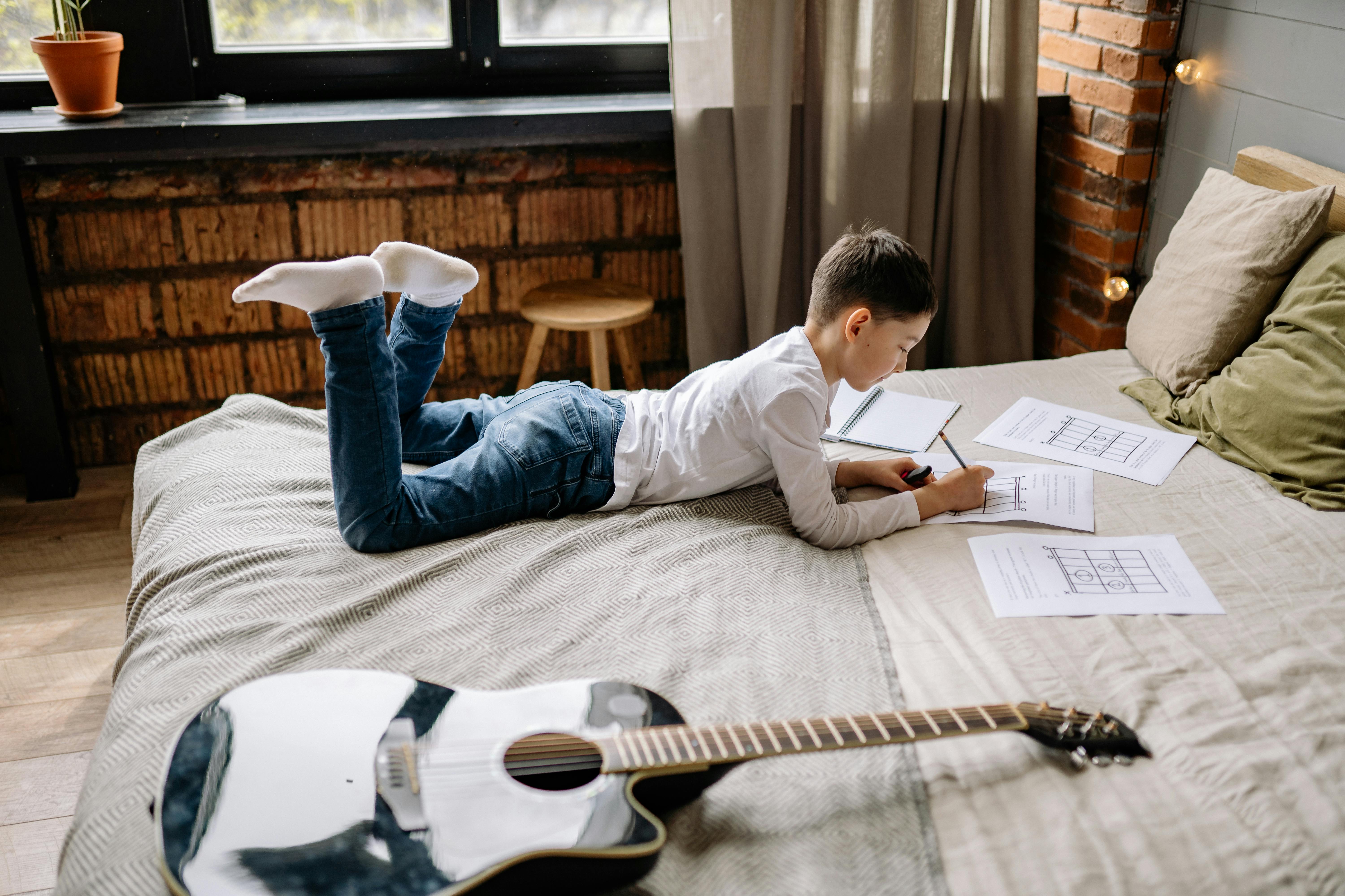 A Boy Writing on the Paper · Free Stock Photo