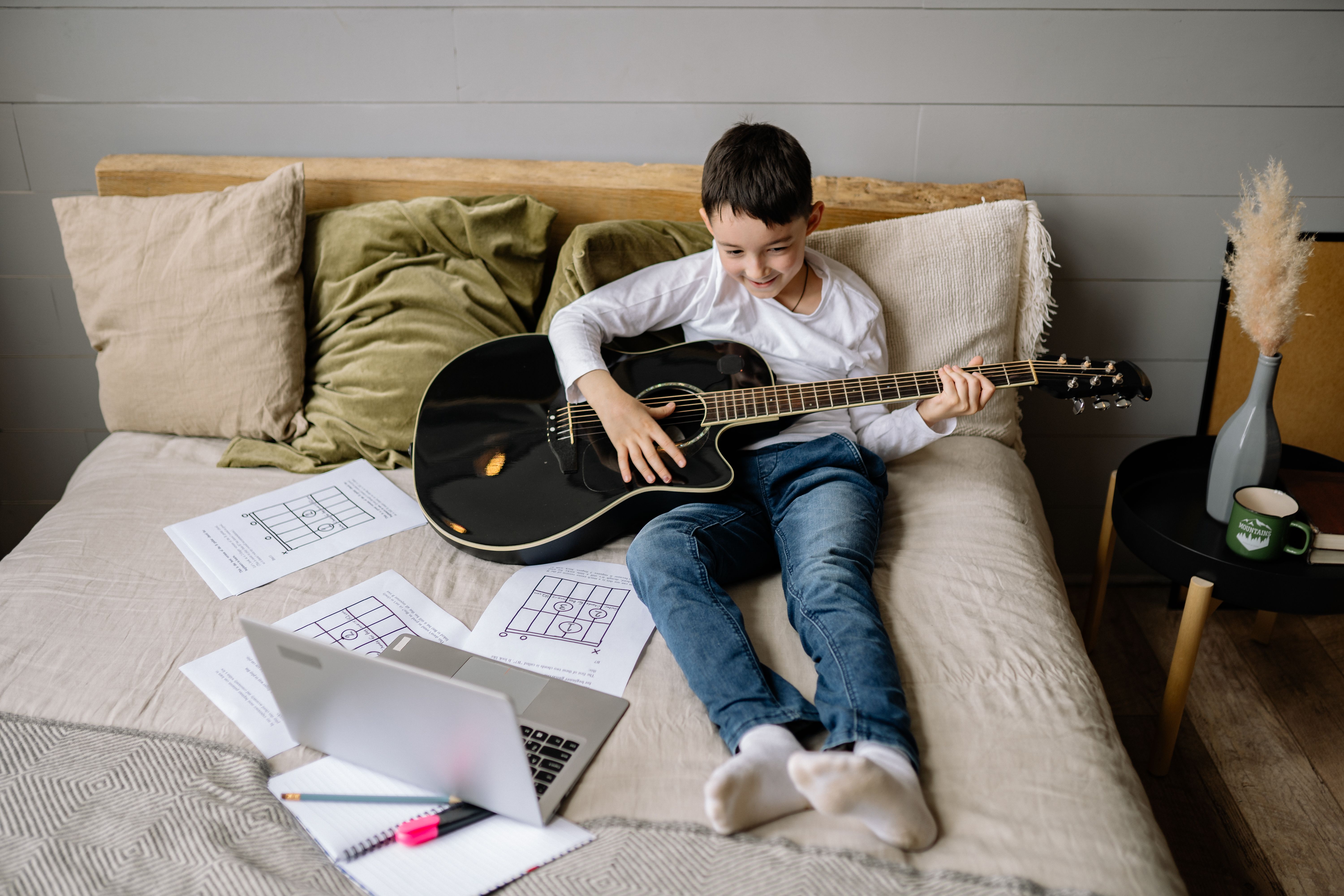A Boy in White Long Sleeves Sitting beside an Acoustic Guitar · Free ...