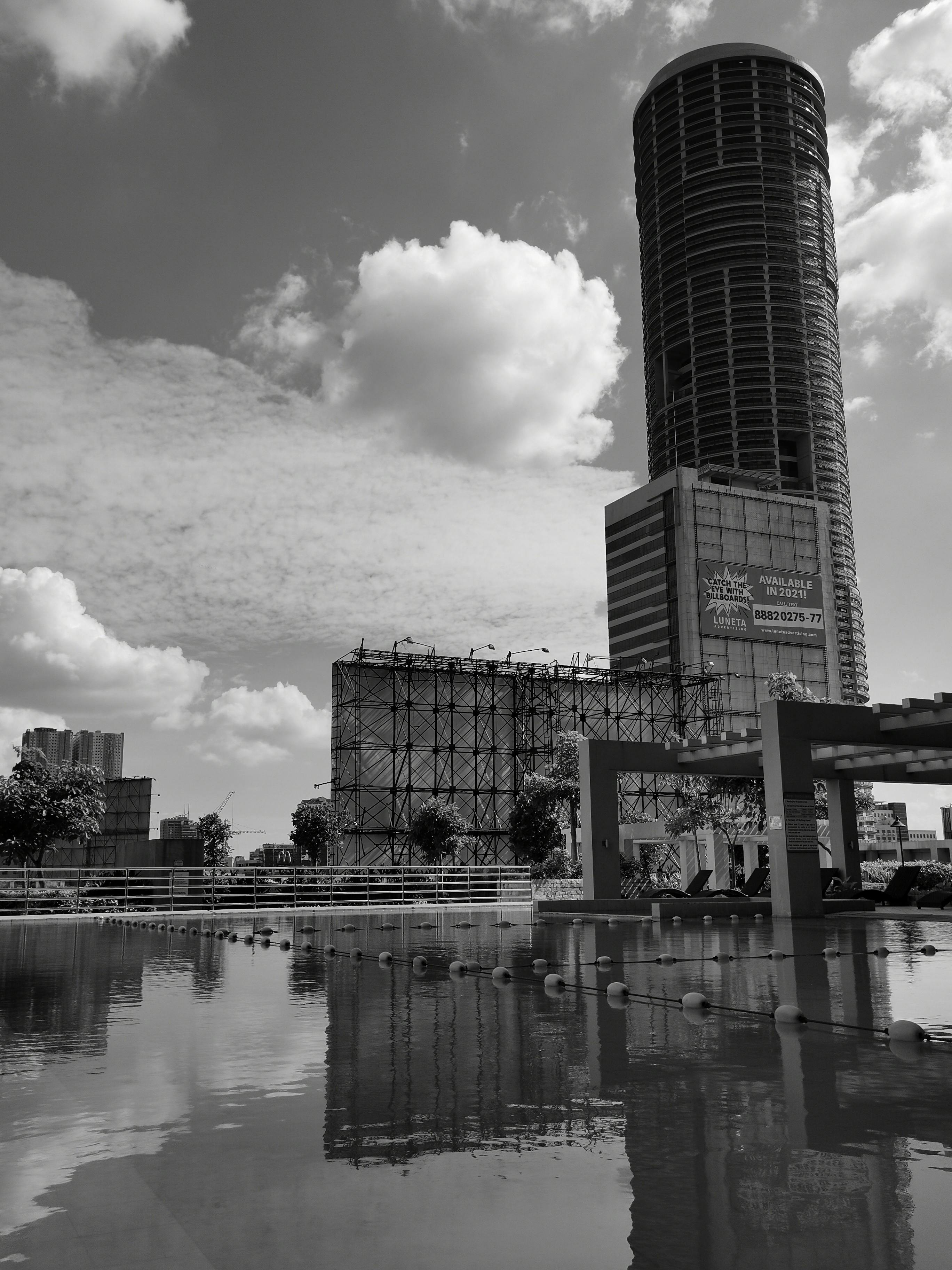 Grayscale Photo of High Rise Building Near Body of Water · Free Stock Photo