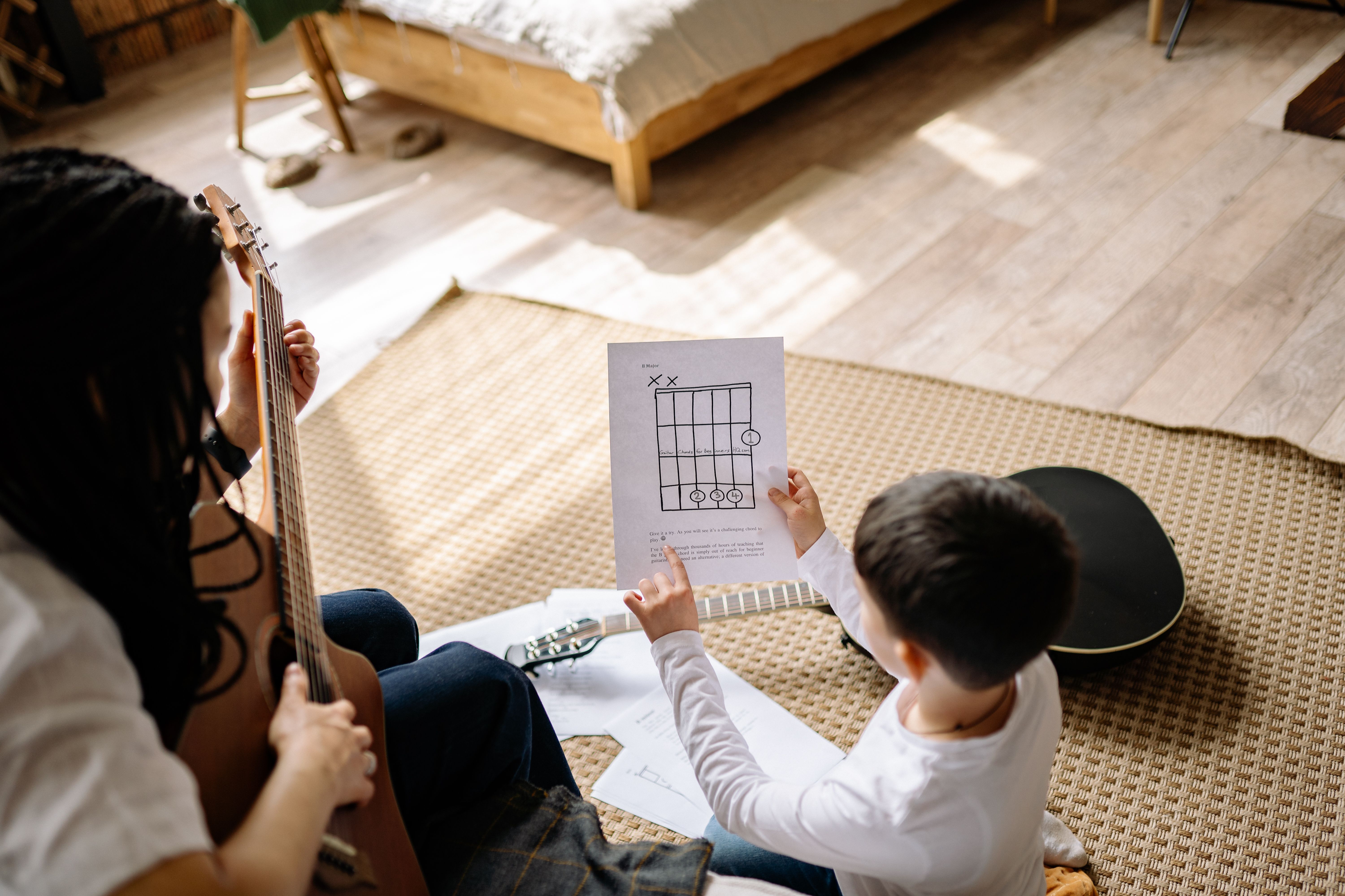 Boy Pointing at a Music Sheet · Free Stock Photo