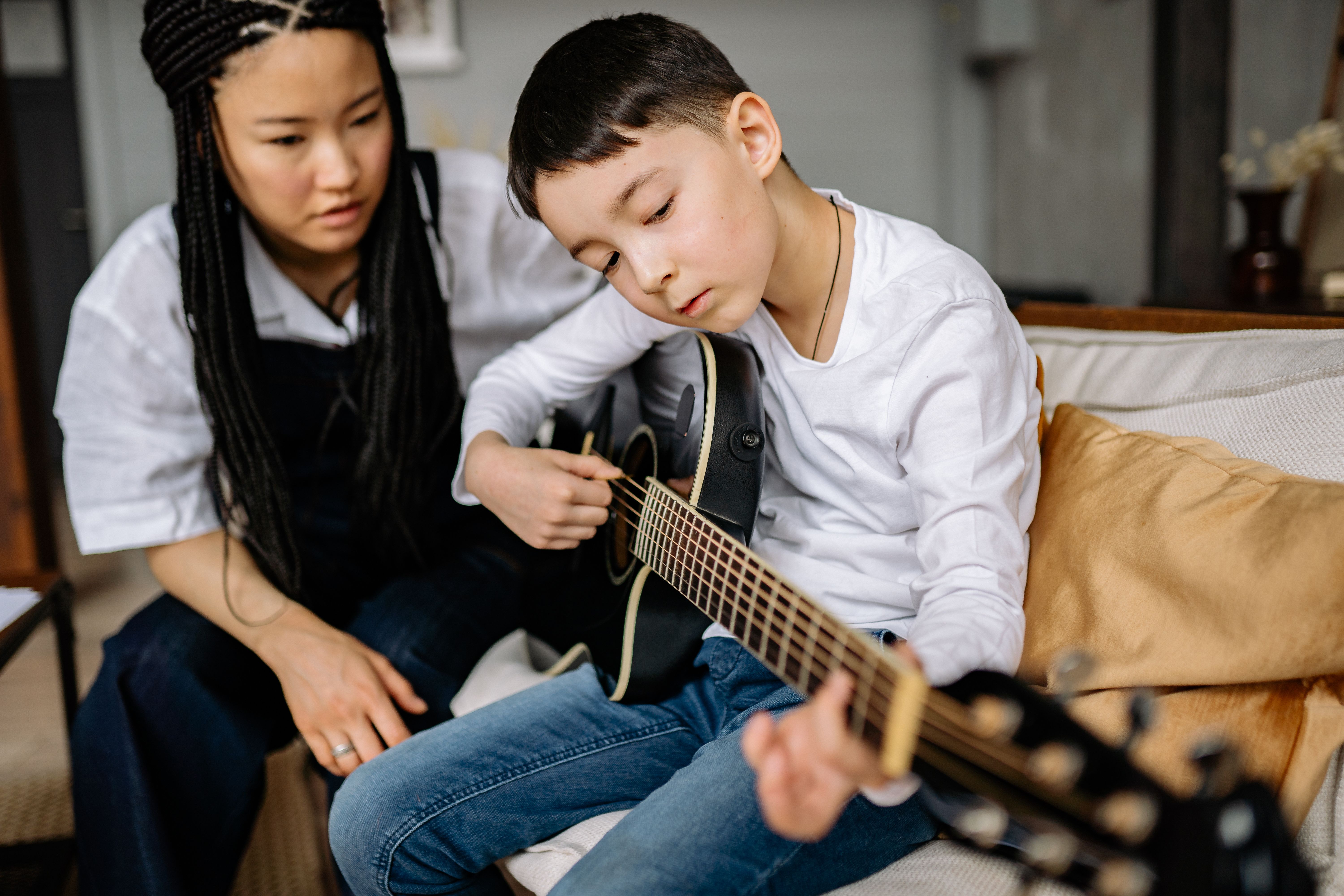 A Boy in White Long Sleeves Sitting beside an Acoustic Guitar · Free ...