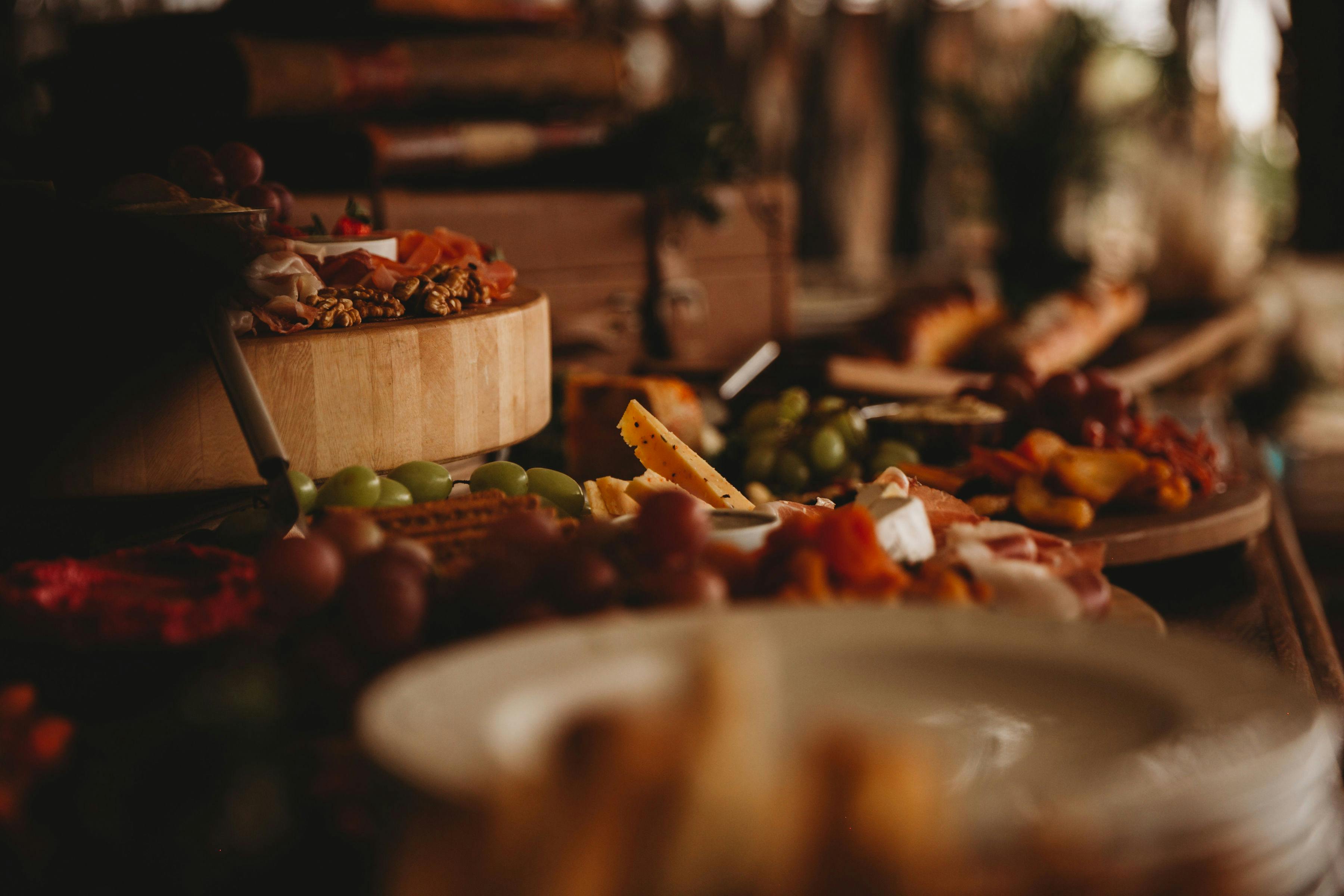 Close Up of Hand Holding Food on Feast · Free Stock Photo