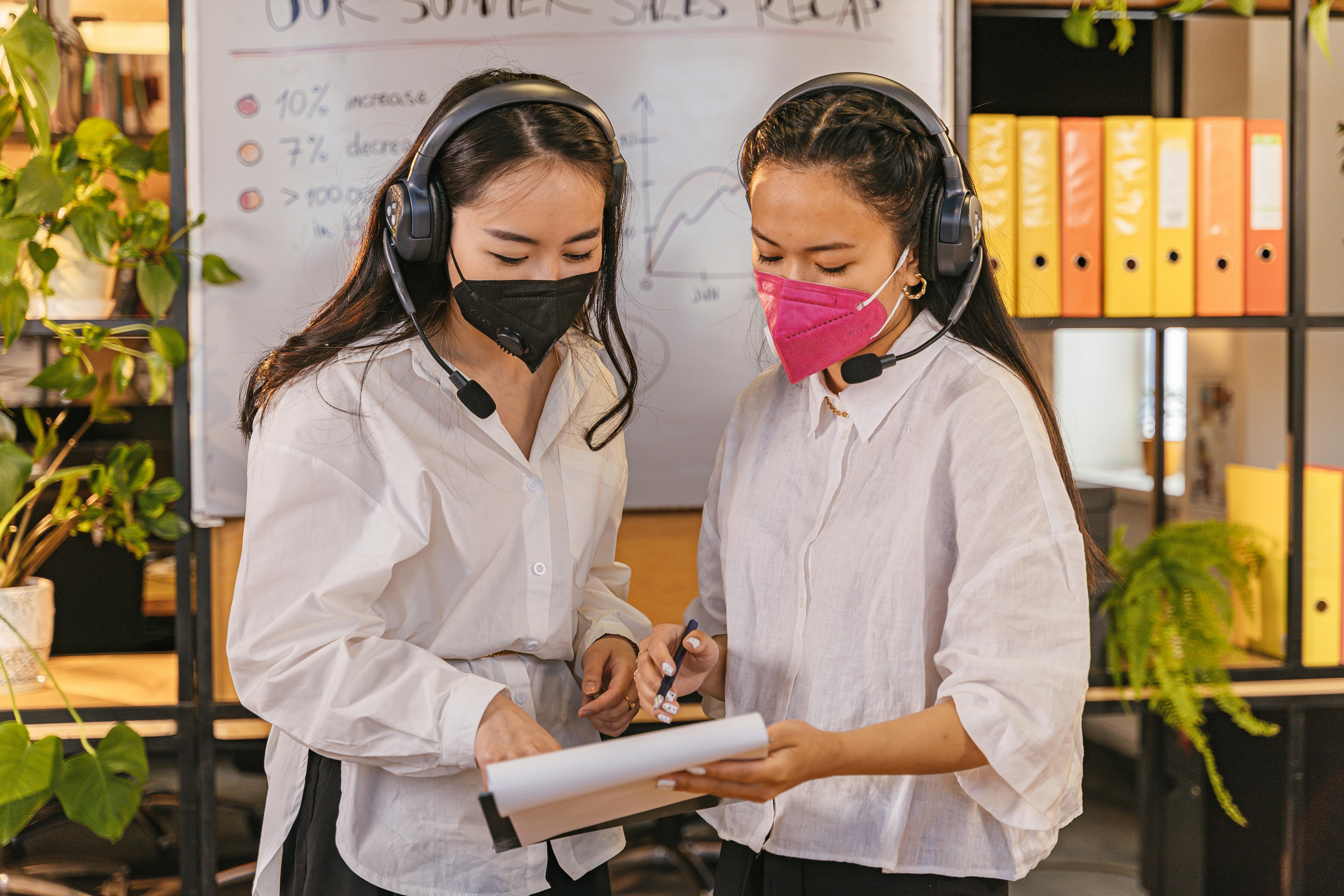 Two Women Wearing Headsets and Face Masks · Free Stock Photo