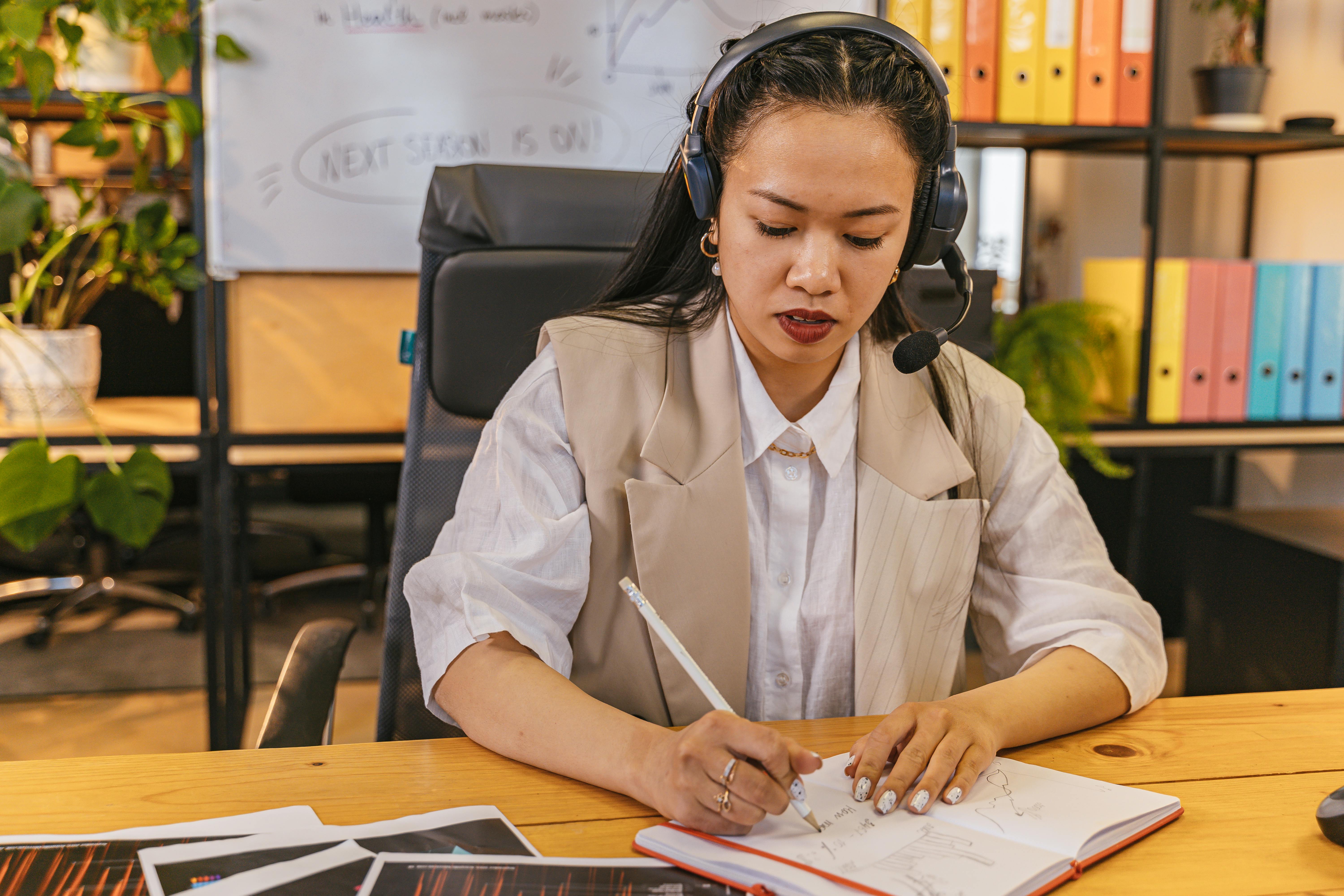 Portrait of a Woman Wearing a Headset with a Microphone in an Office ...