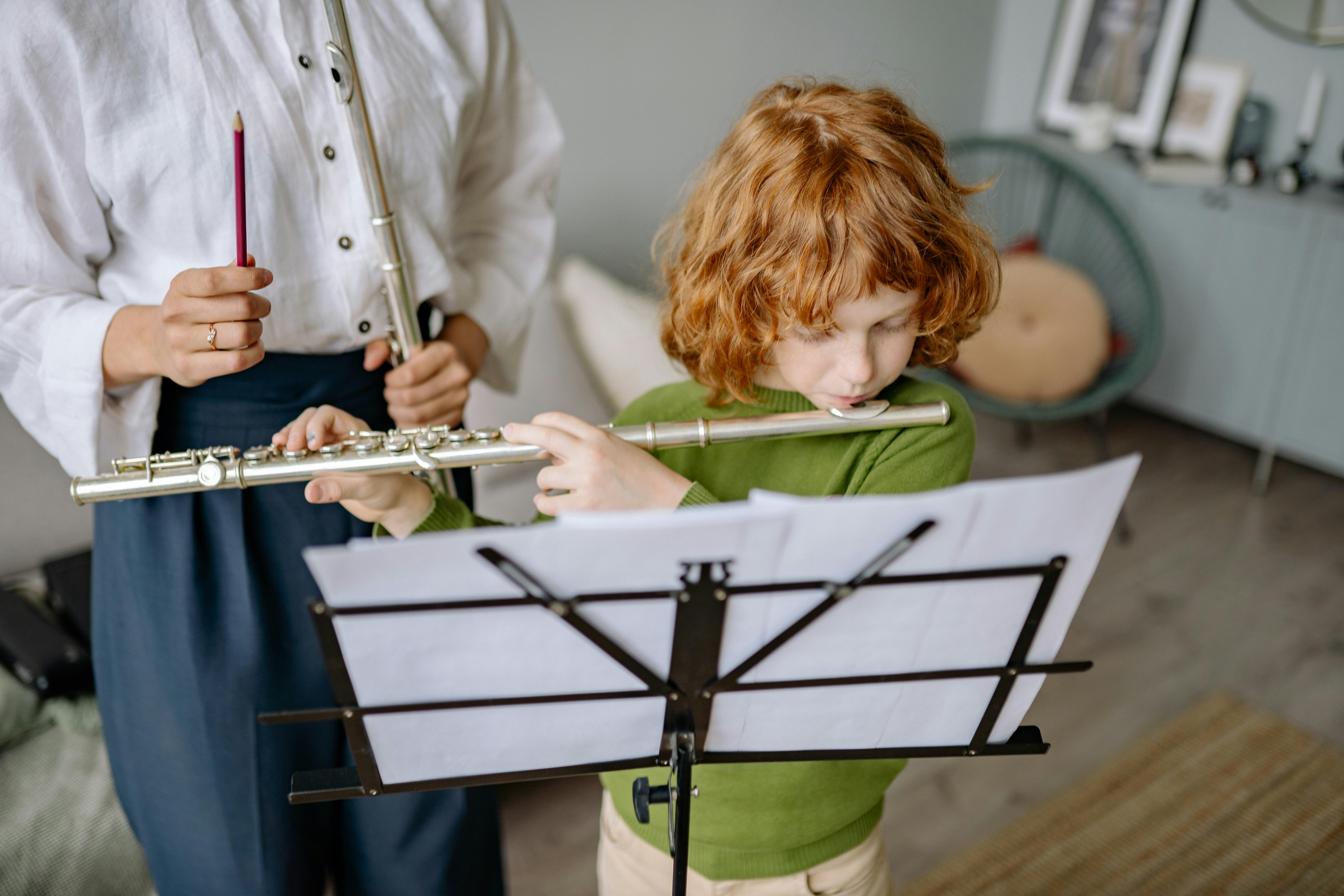 A Kid Standing by the Wall and Playing on a Traditional Musical ...