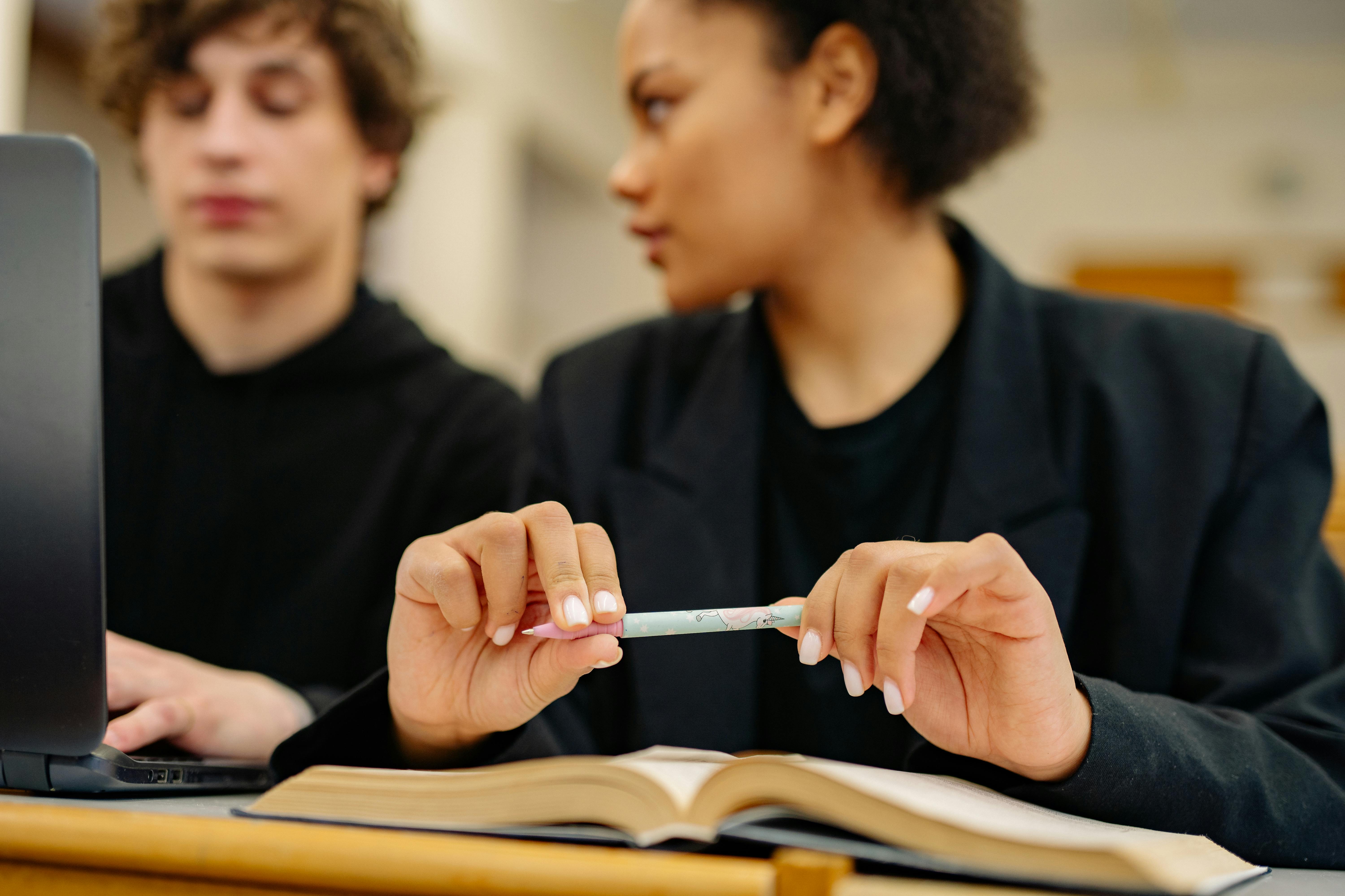 Woman Holding a Pen · Free Stock Photo