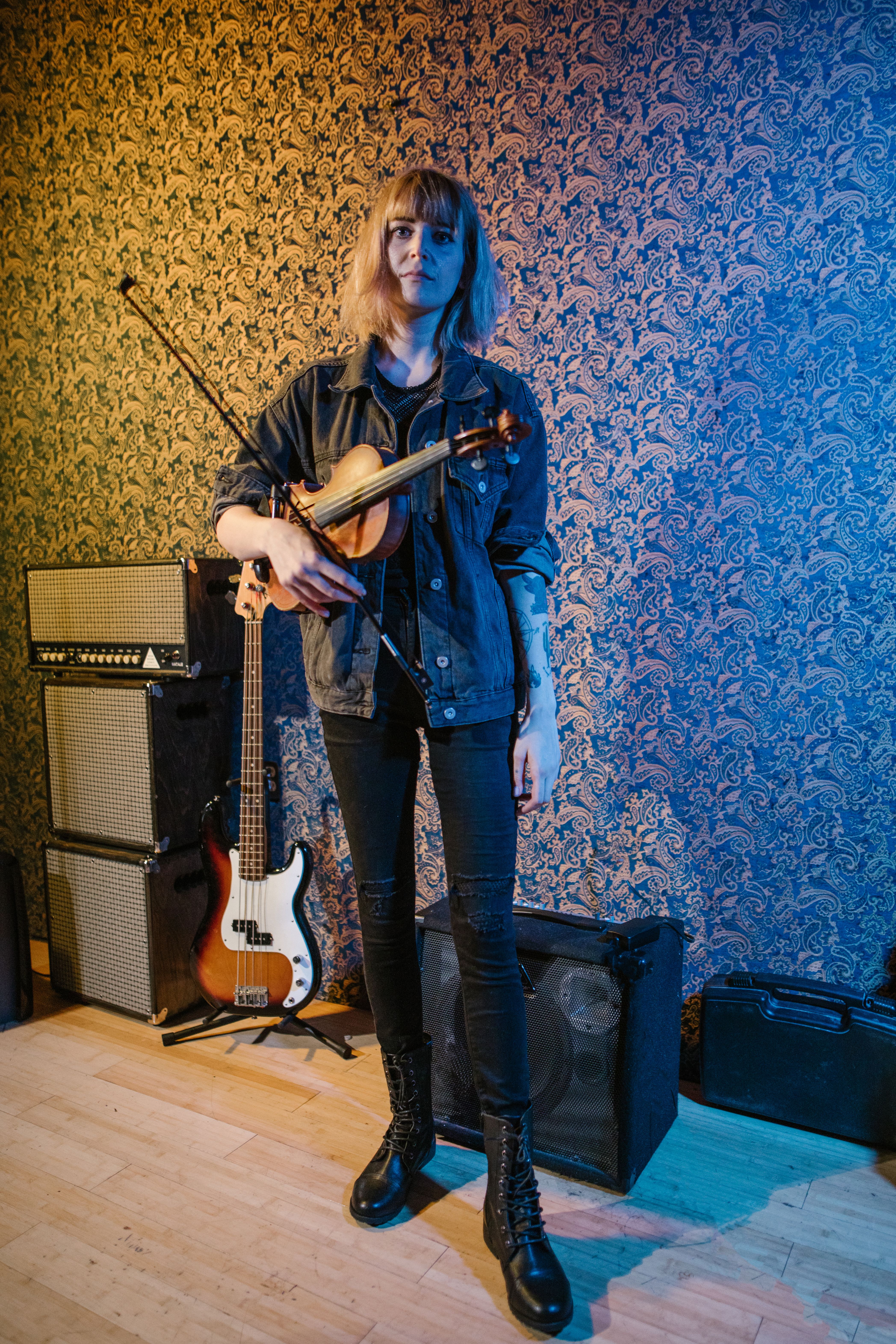 A Woman in Denim Jacket Holding a Violin · Free Stock Photo