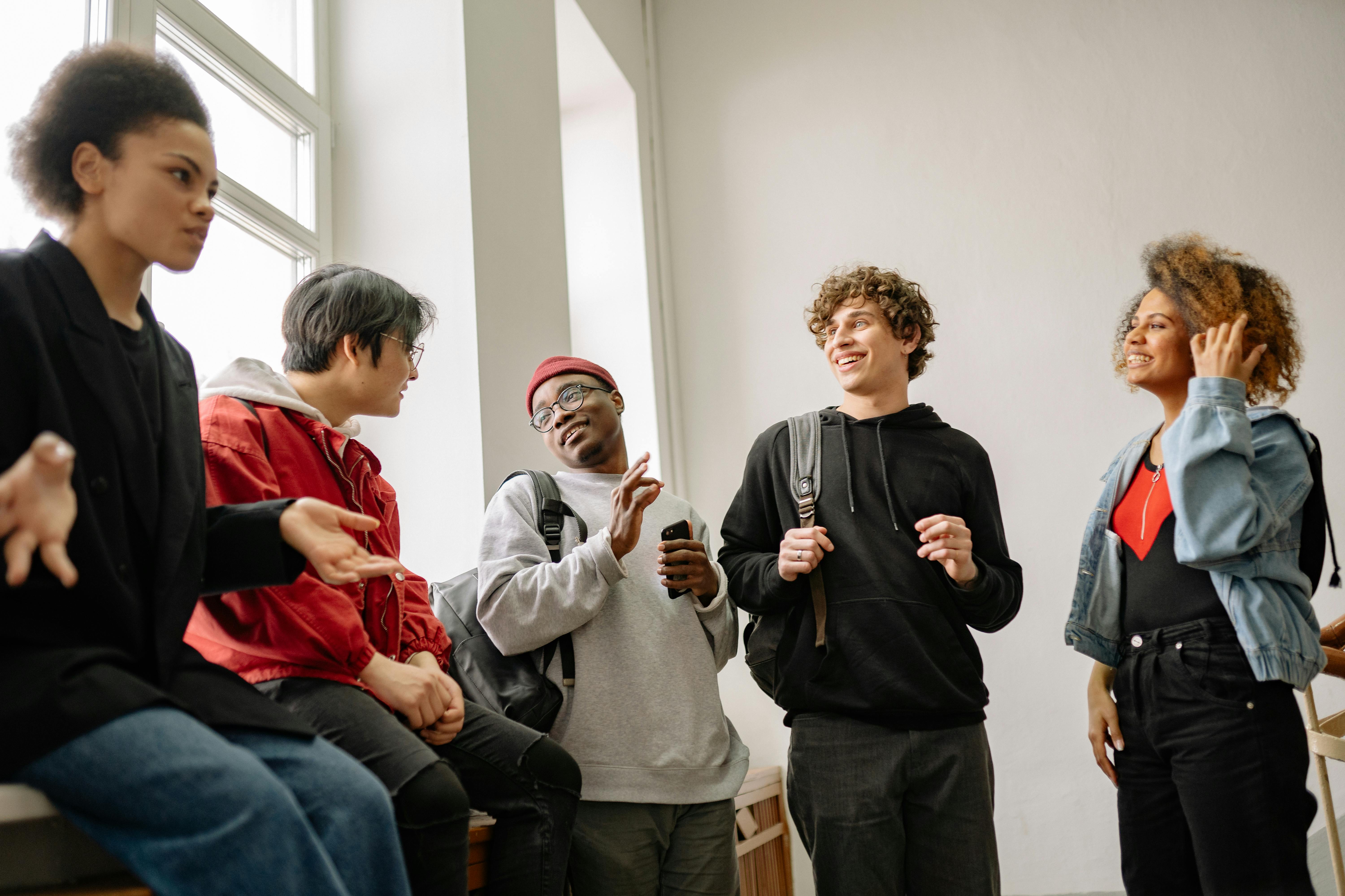 Students Talking while on a Staircase Landing · Free Stock Photo