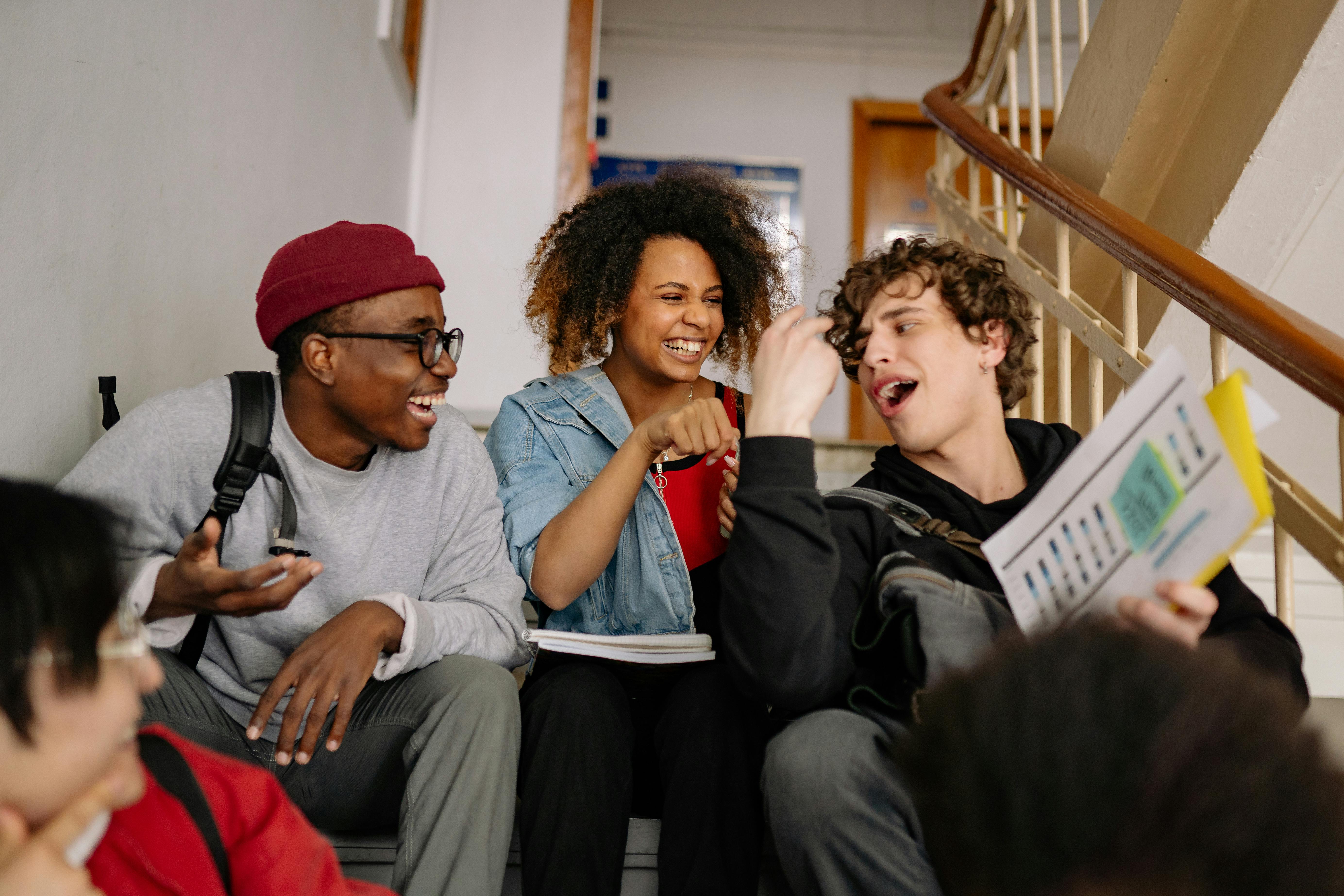 Students Talking while on a Staircase Landing · Free Stock Photo