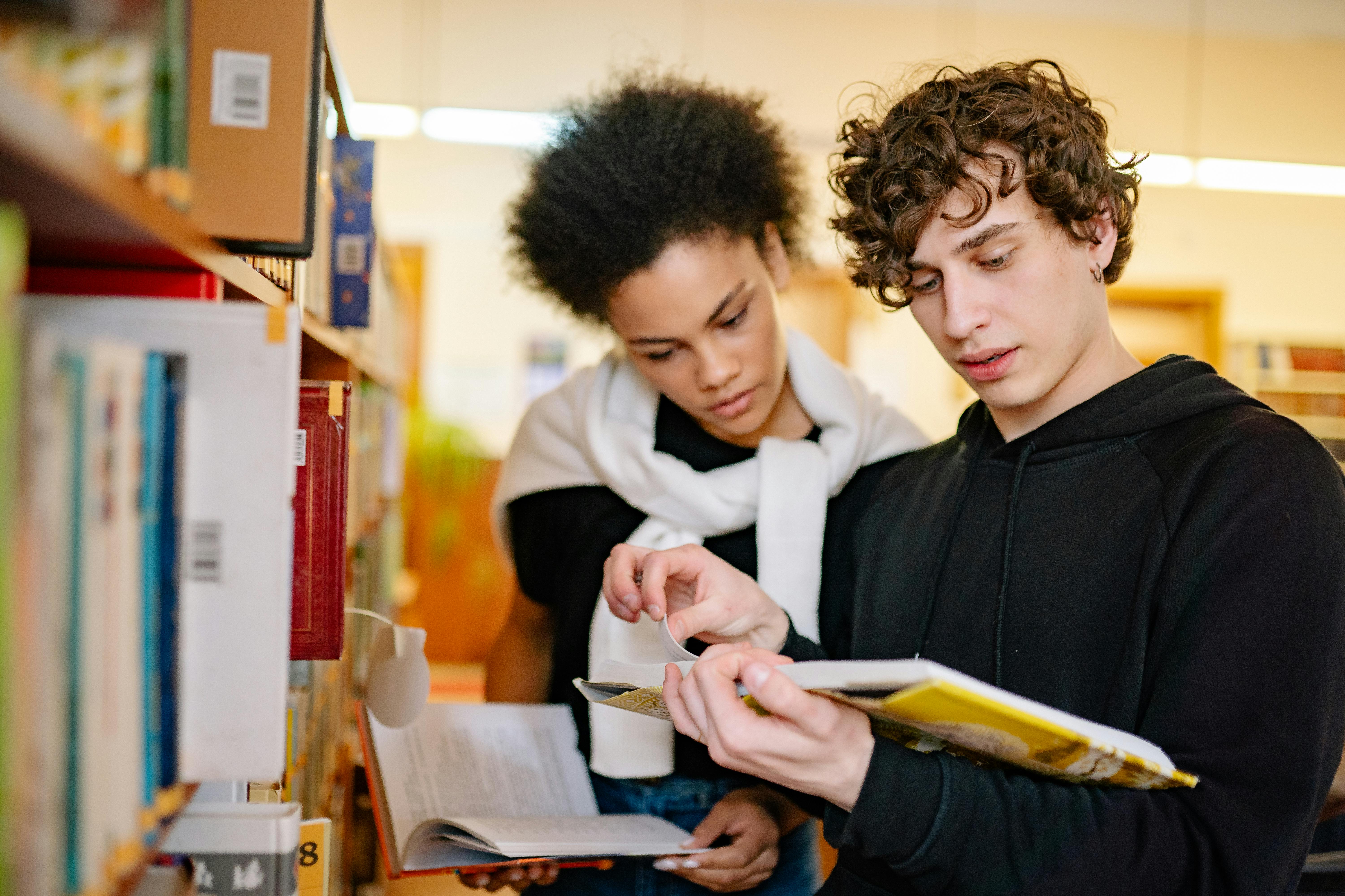 Teenagers with Books at Library · Free Stock Photo