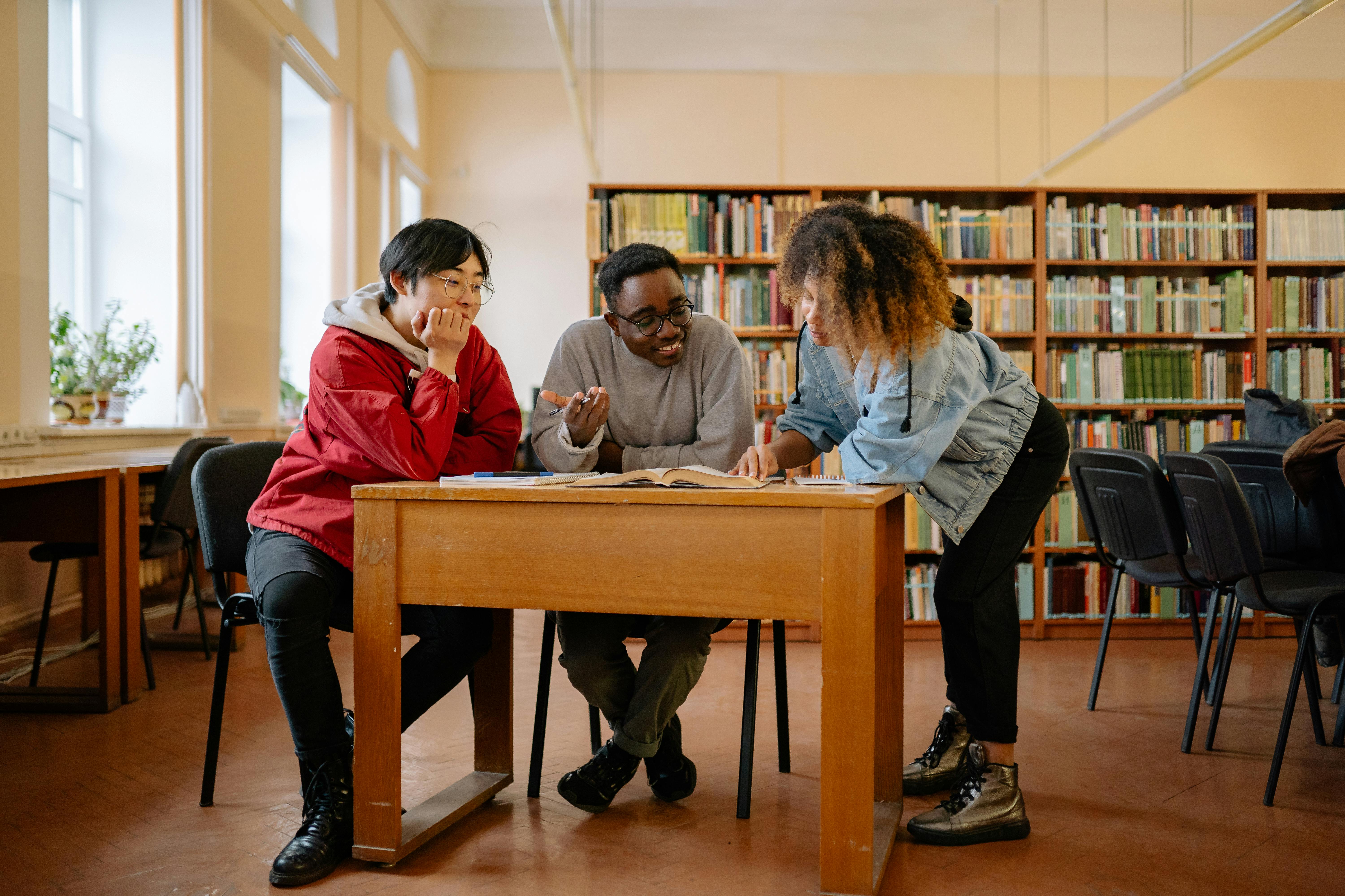 Three People in the Library · Free Stock Photo