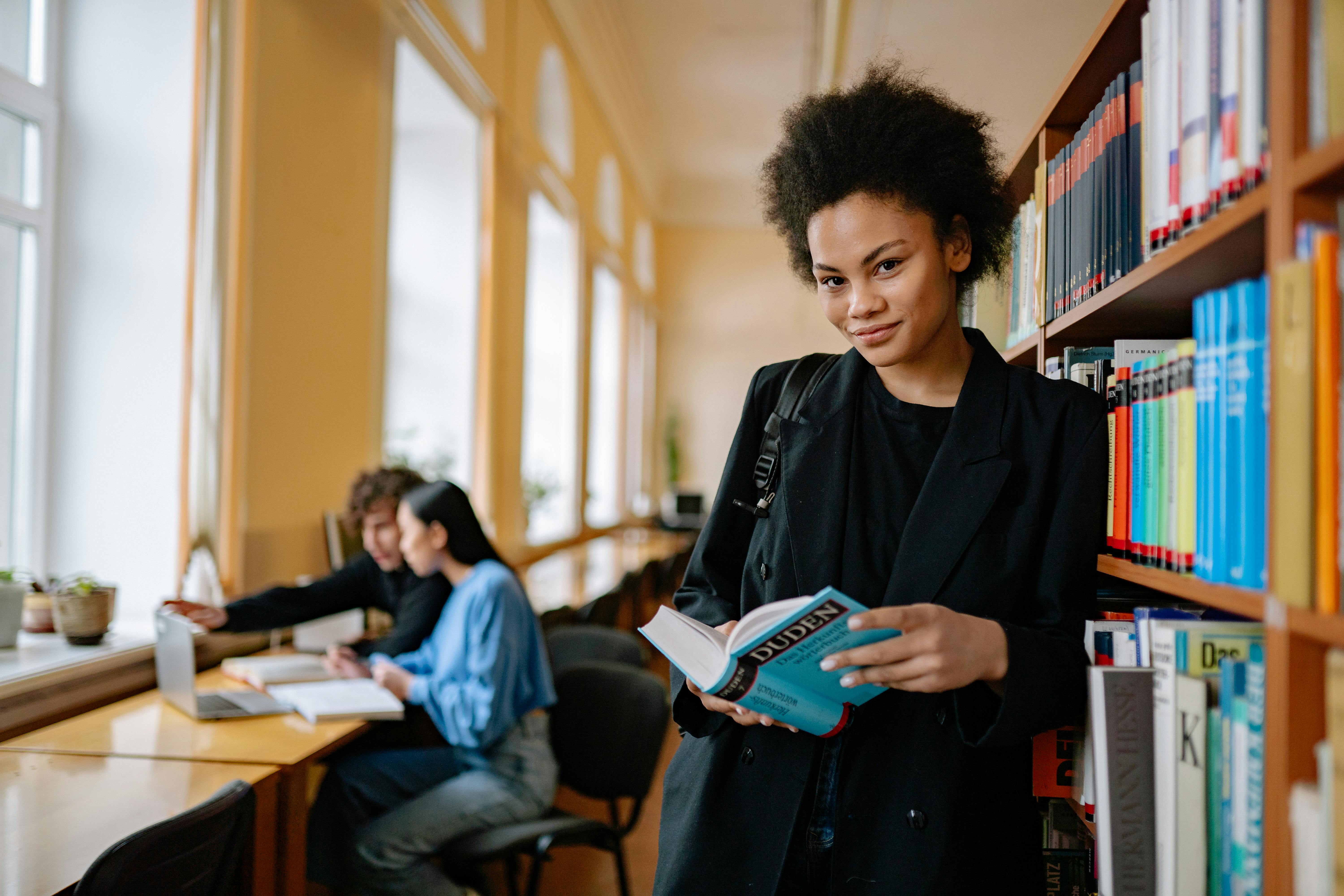 Woman Standing in a Library · Free Stock Photo