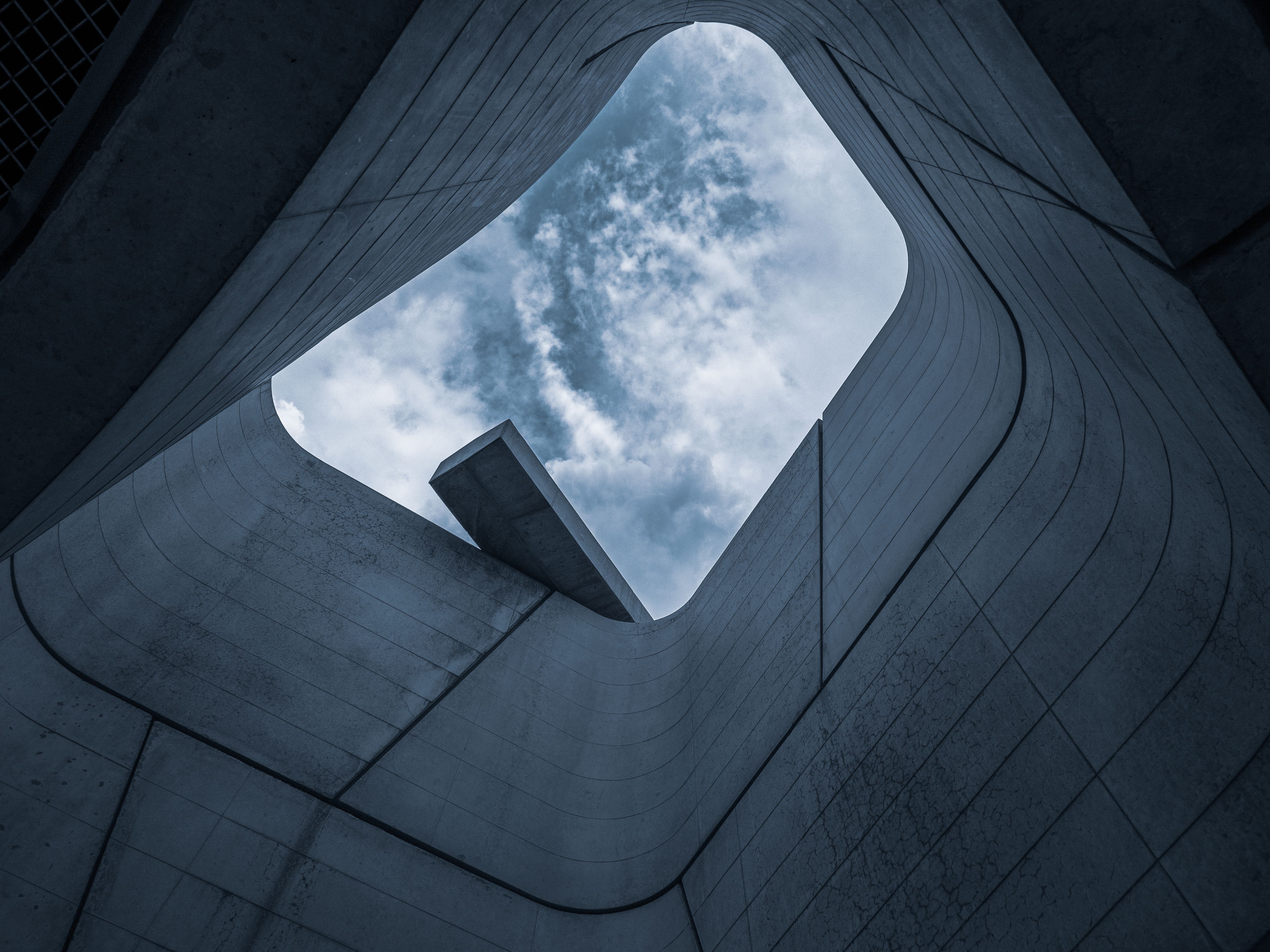 View of the Sky Between Concrete Blocks · Free Stock Photo