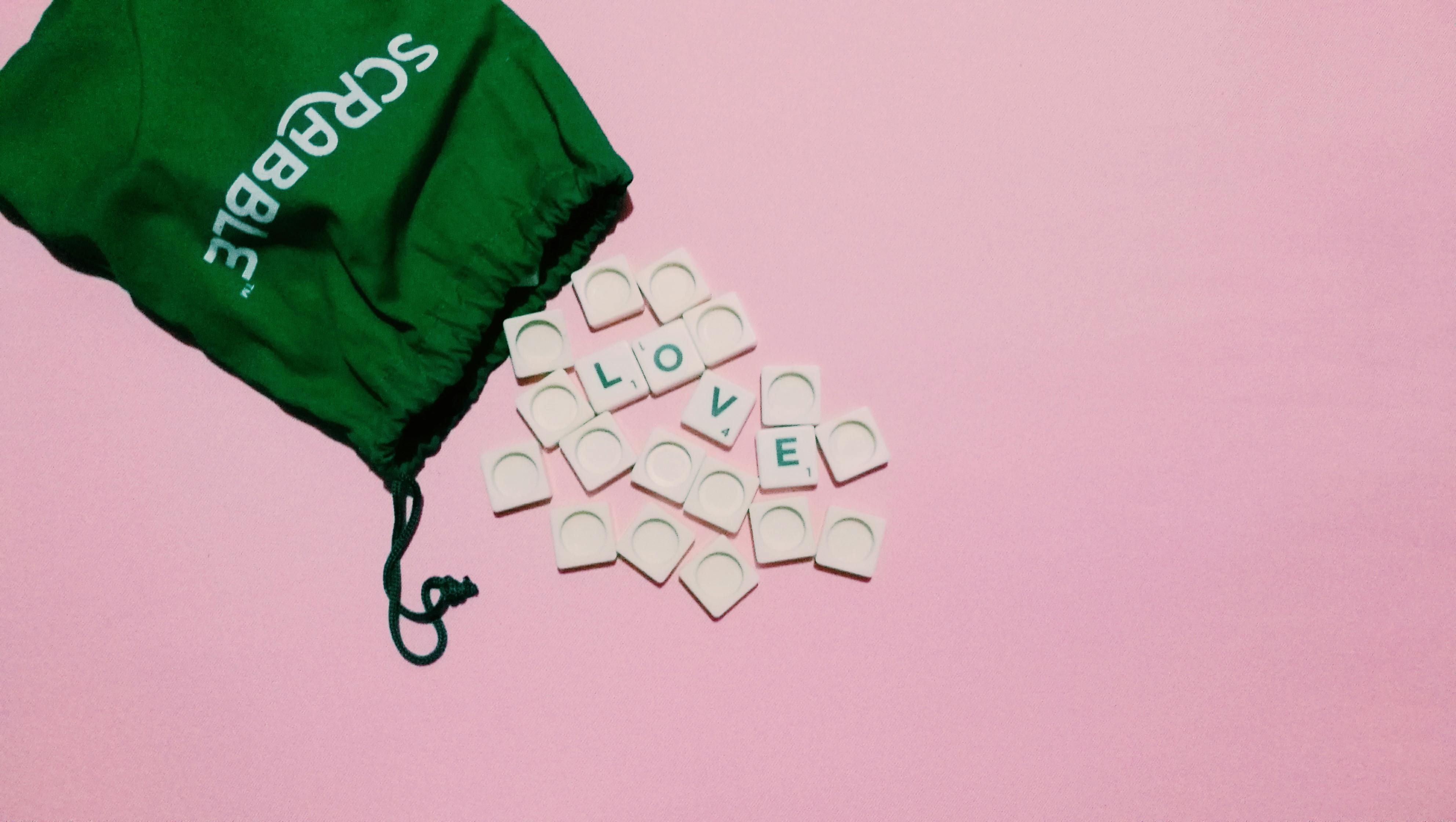 Love Arranged From Scrabble Letter Tiles Falling Out of a Bag · Free ...