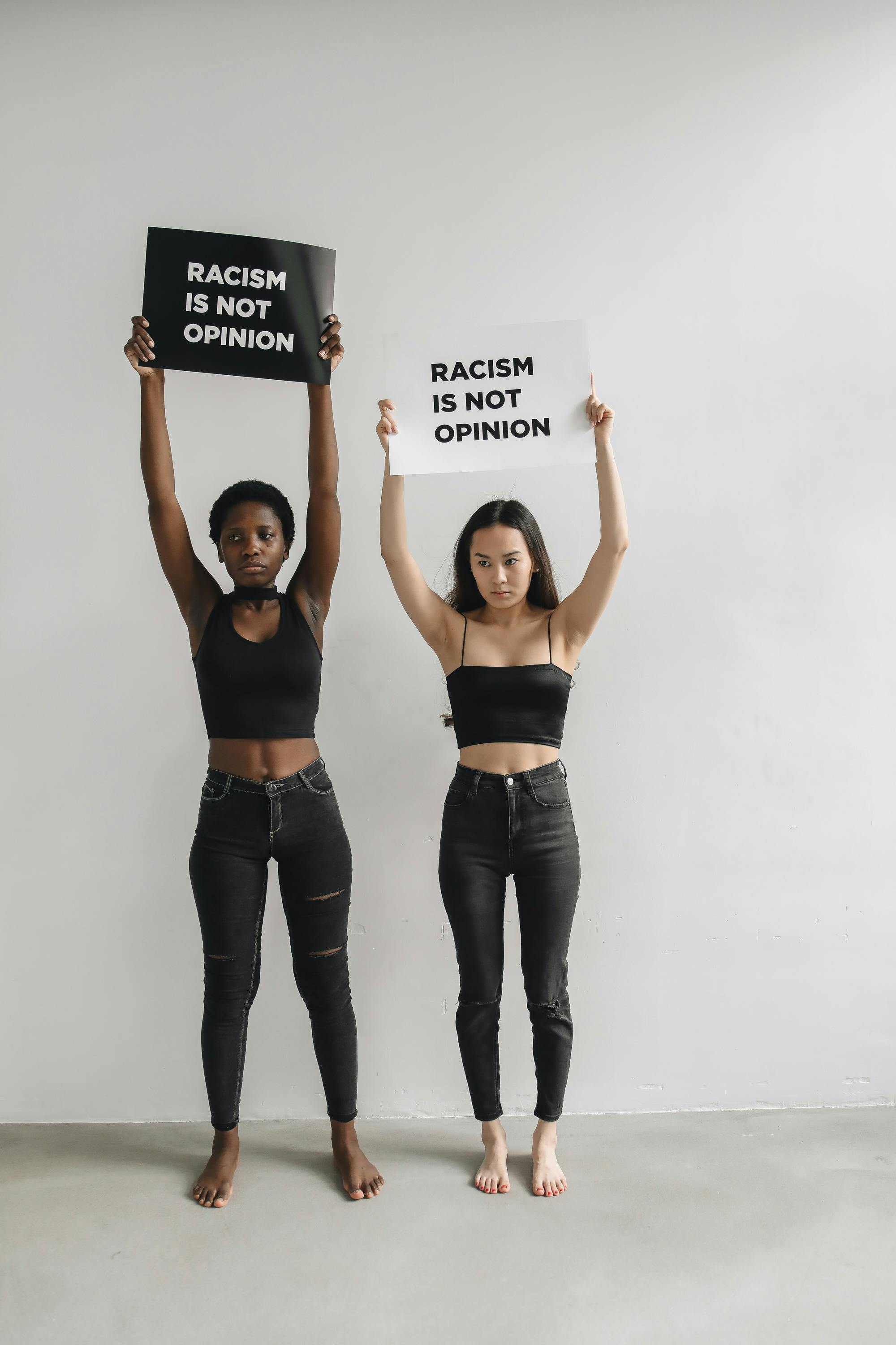 Two Women Standing While Holding Signages · Free Stock Photo