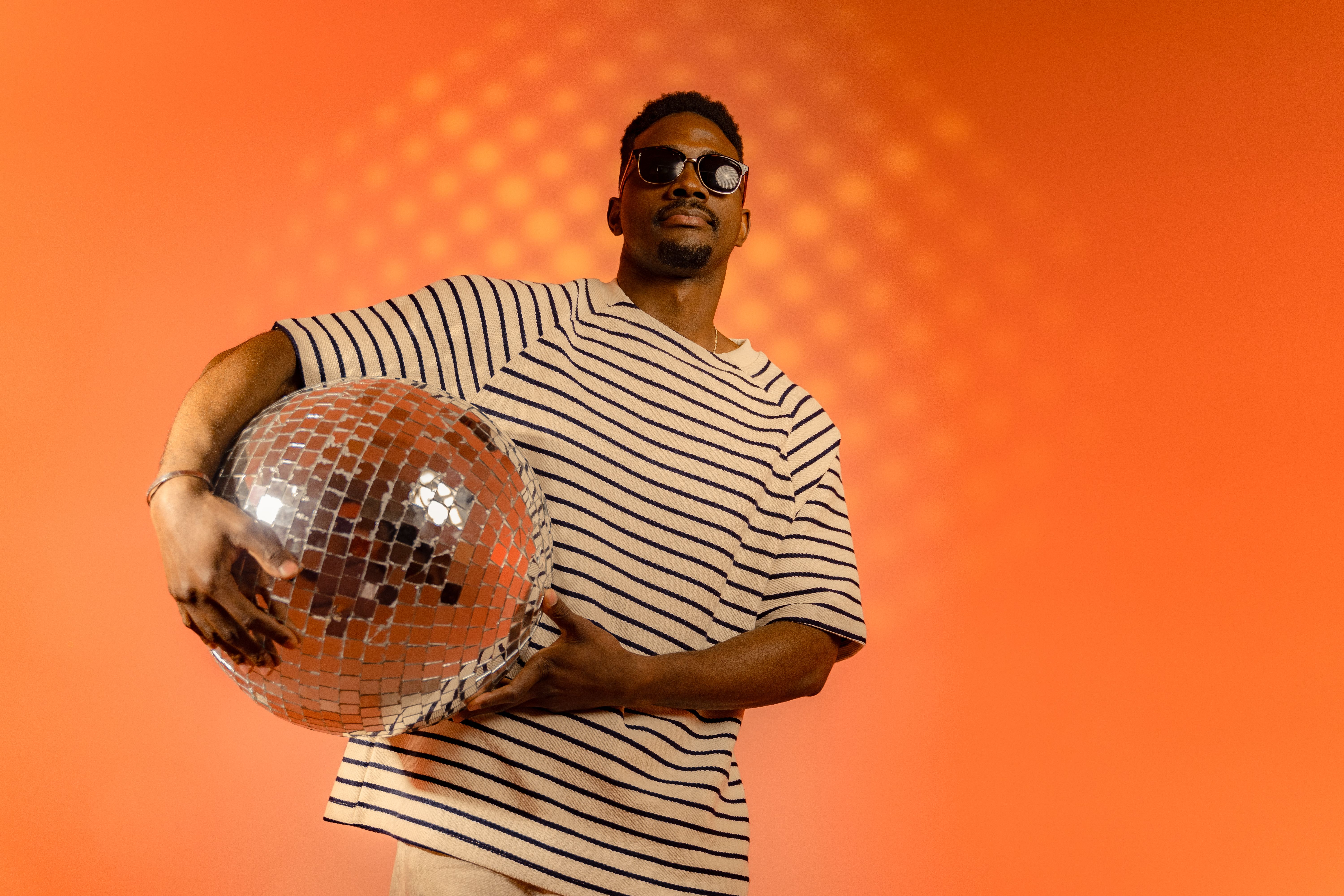 A Man Holding a Disco Ball · Free Stock Photo