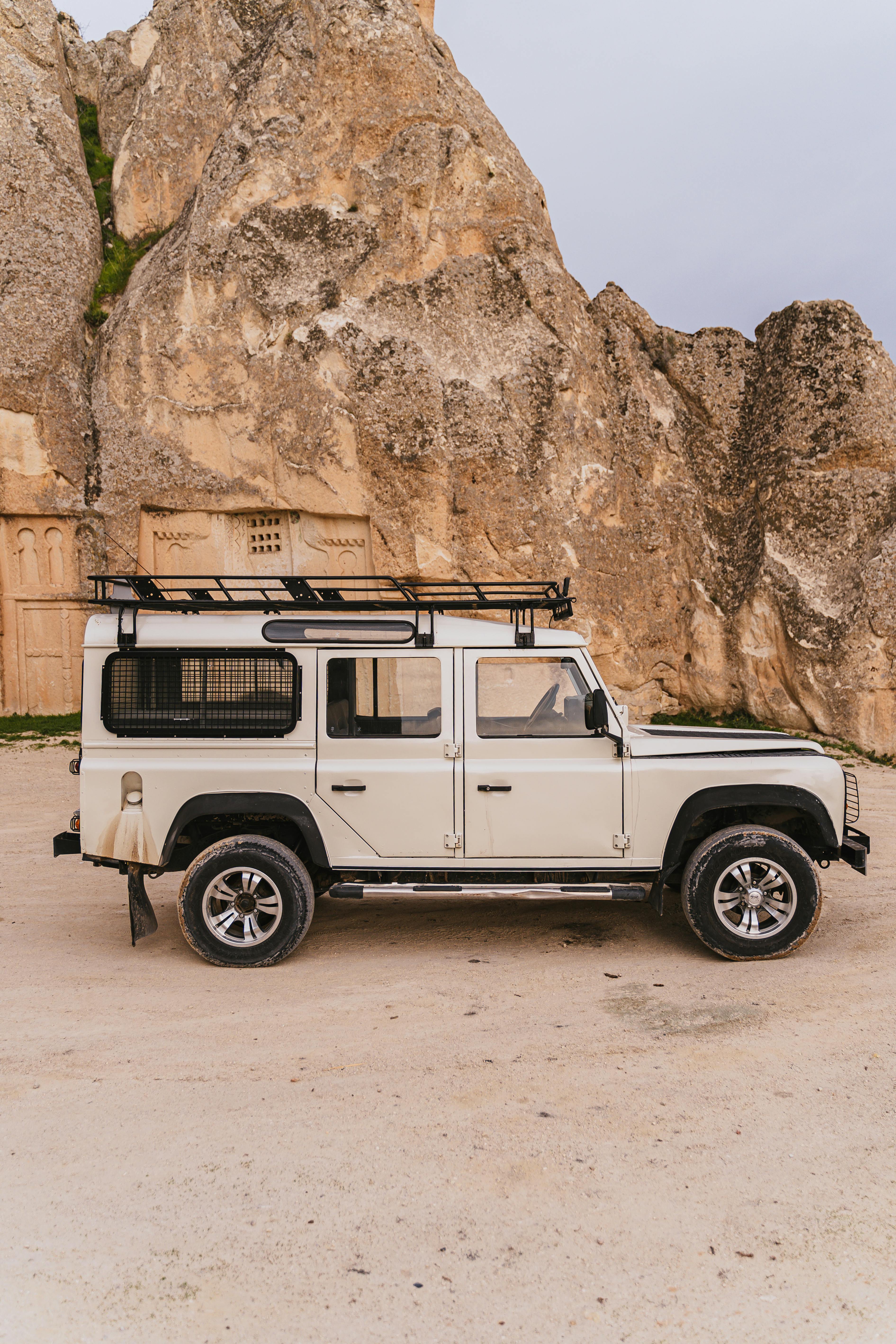 4x4 Car Near Rock Formation · Free Stock Photo
