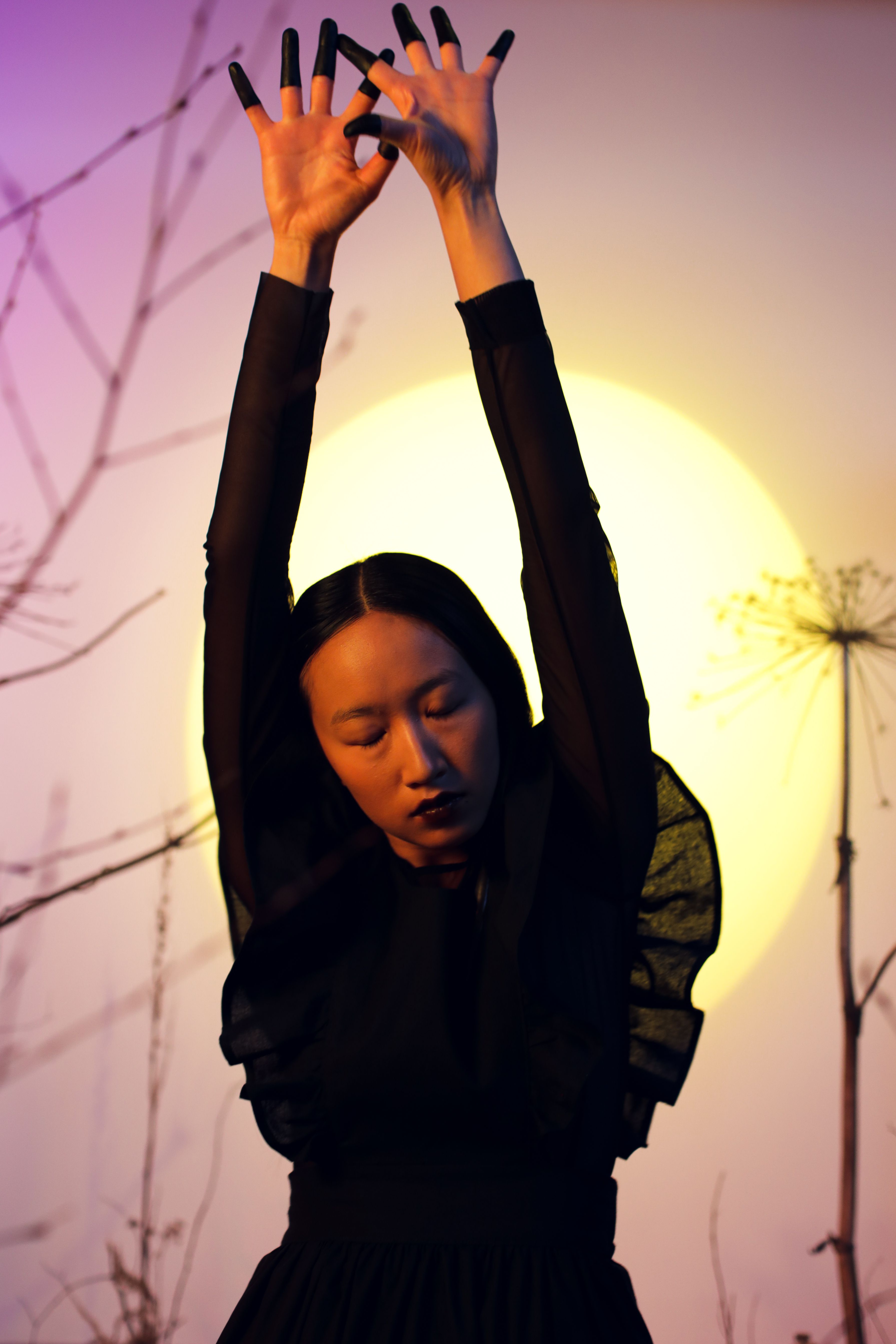 A Woman Backlit by Orange Round Backdrop · Free Stock Photo