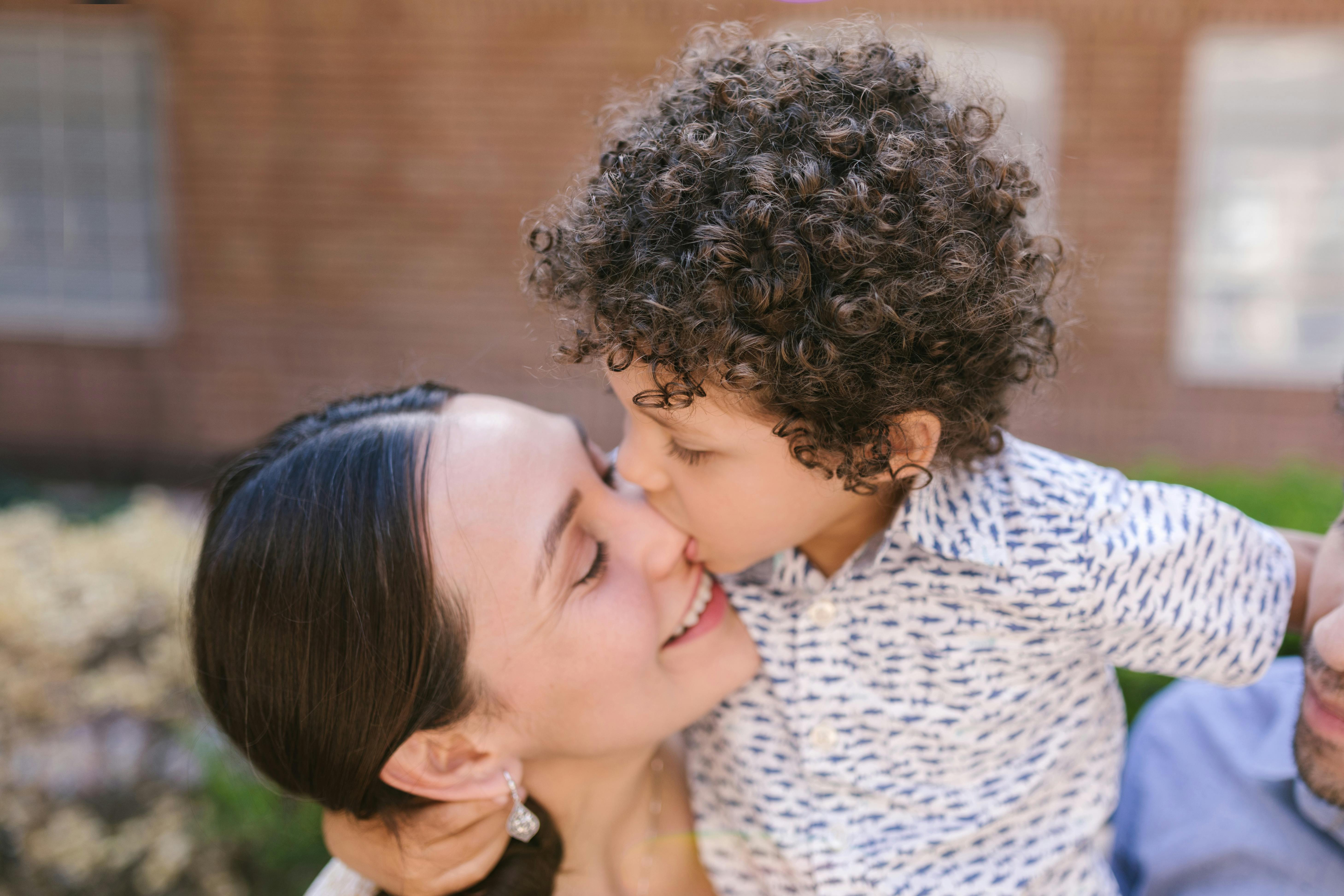 Son Biting His Mothers Nose · Free Stock Photo