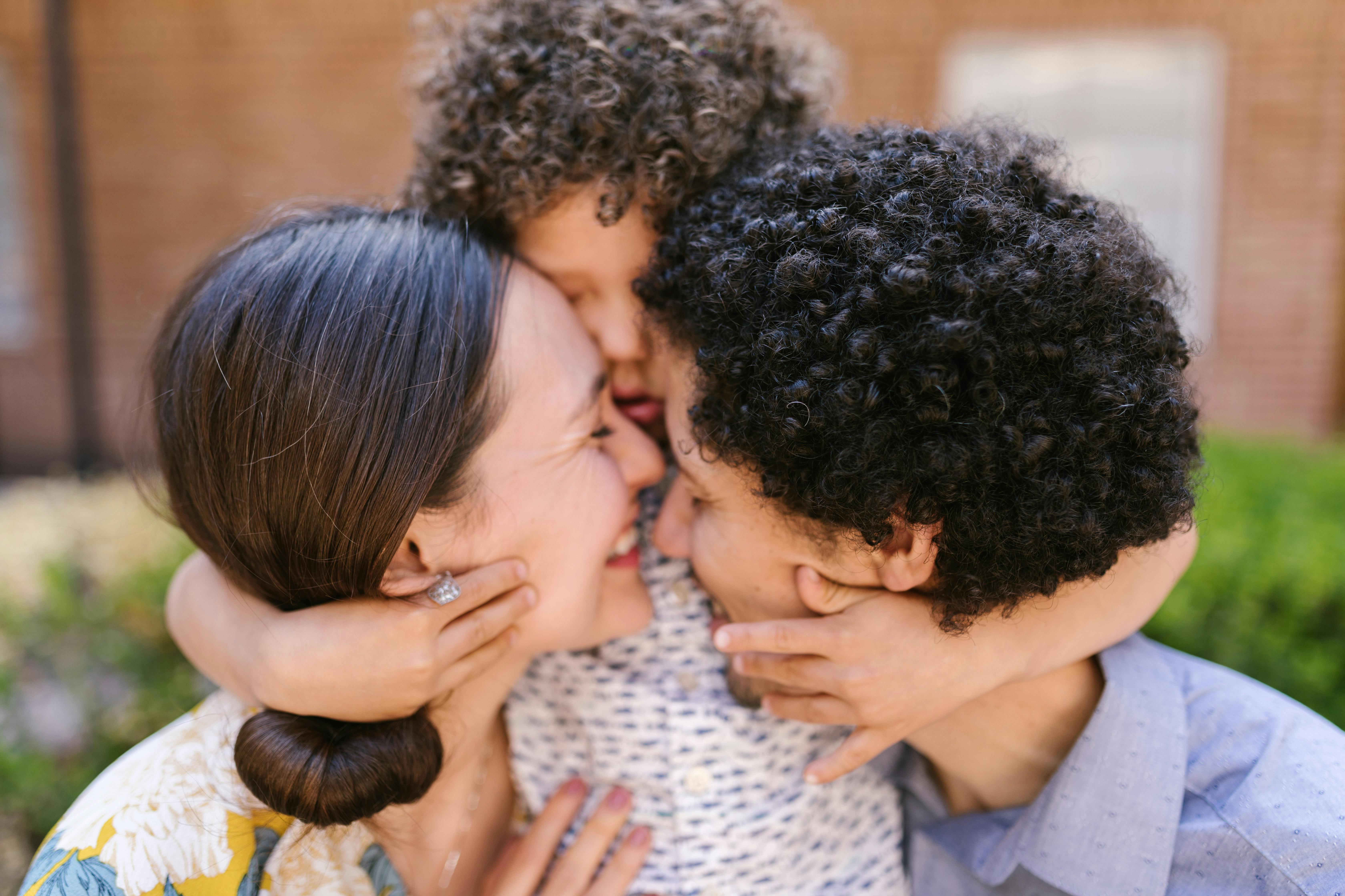 A Boy Hugging His Parents · Free Stock Photo