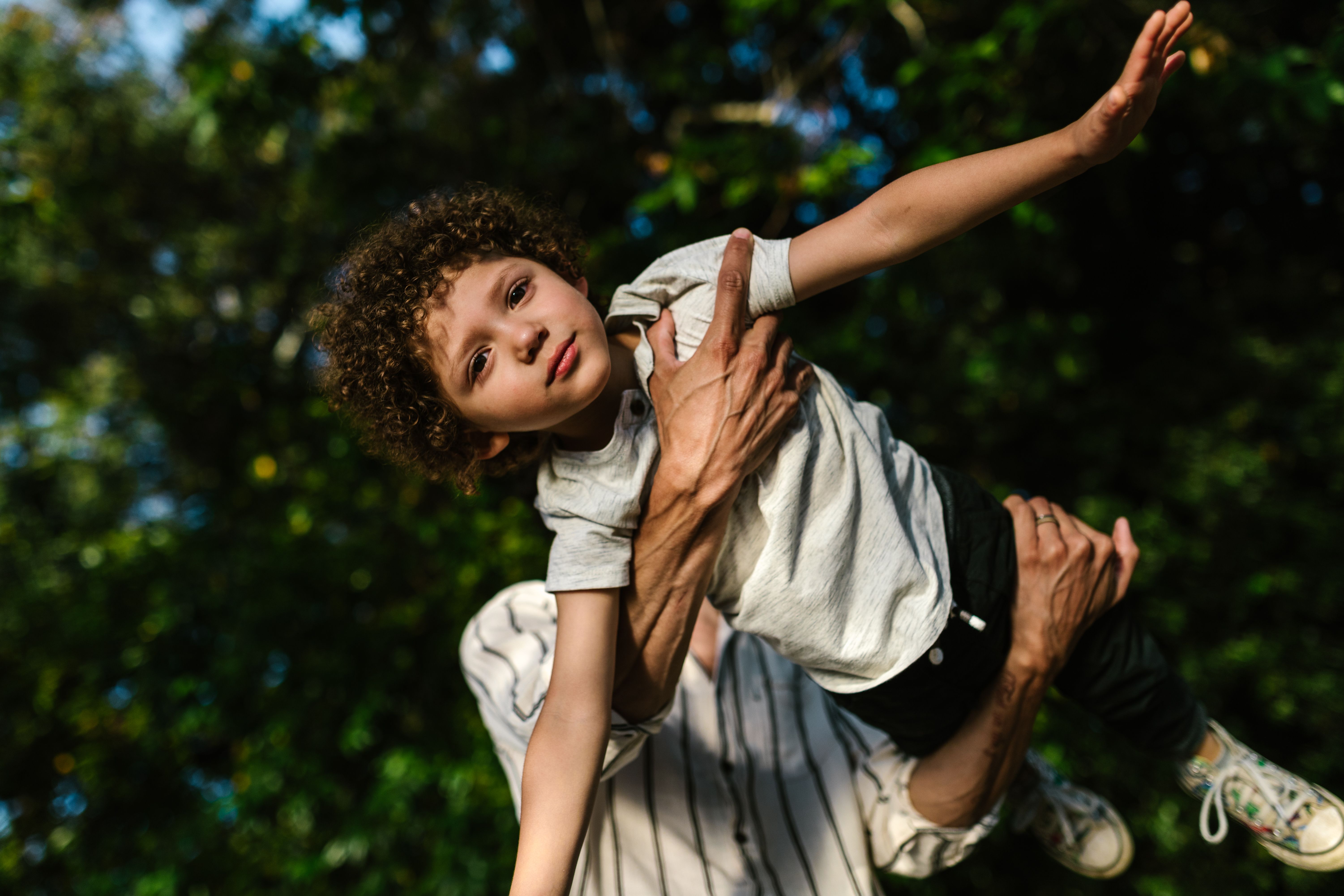 Father Working From Home With Child on His Back · Free Stock Photo