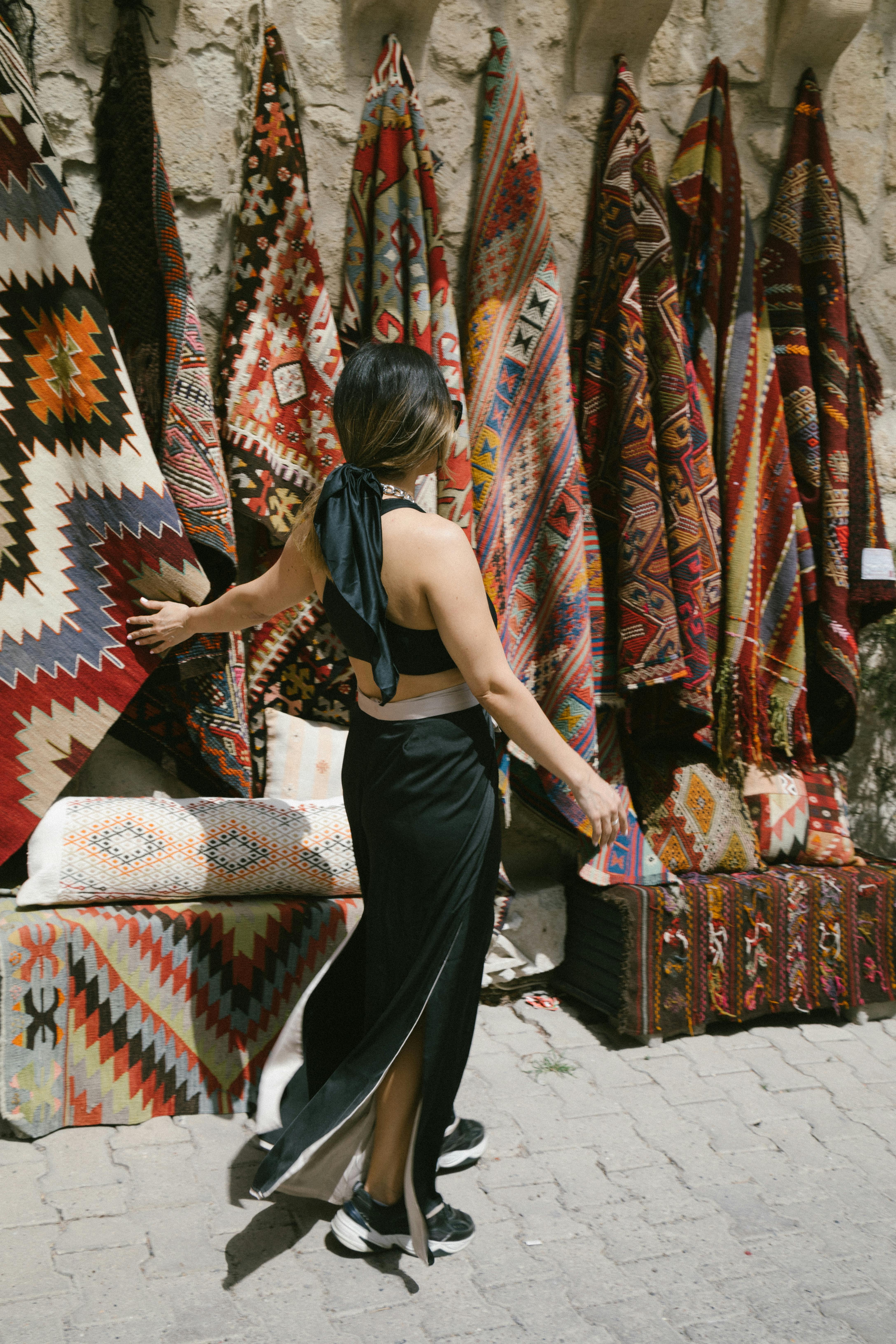 Woman Shopping for Blanket at Market · Free Stock Photo