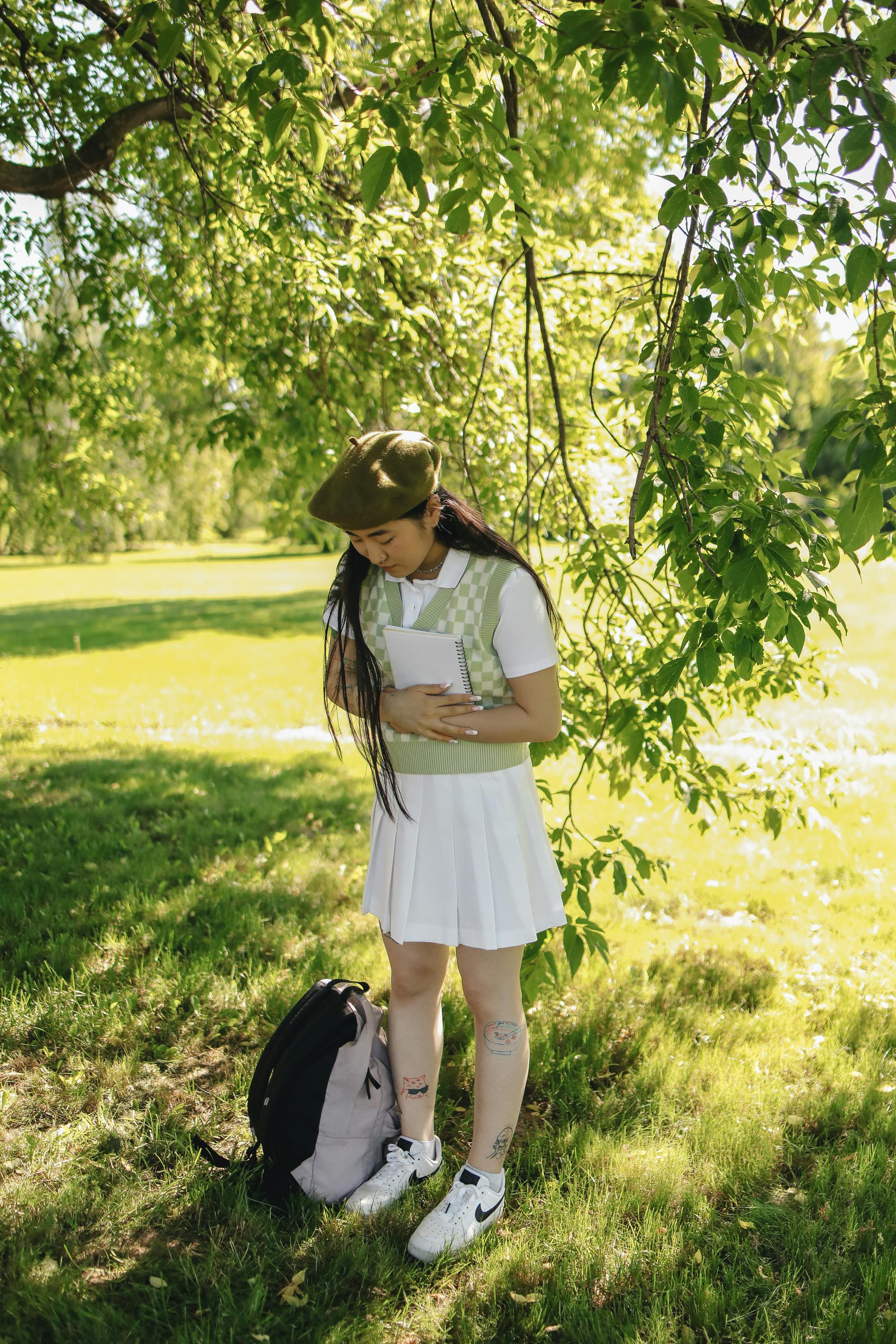 Teenage Girls Wearing Uniforms Having Fun Under a Tree · Free Stock Photo