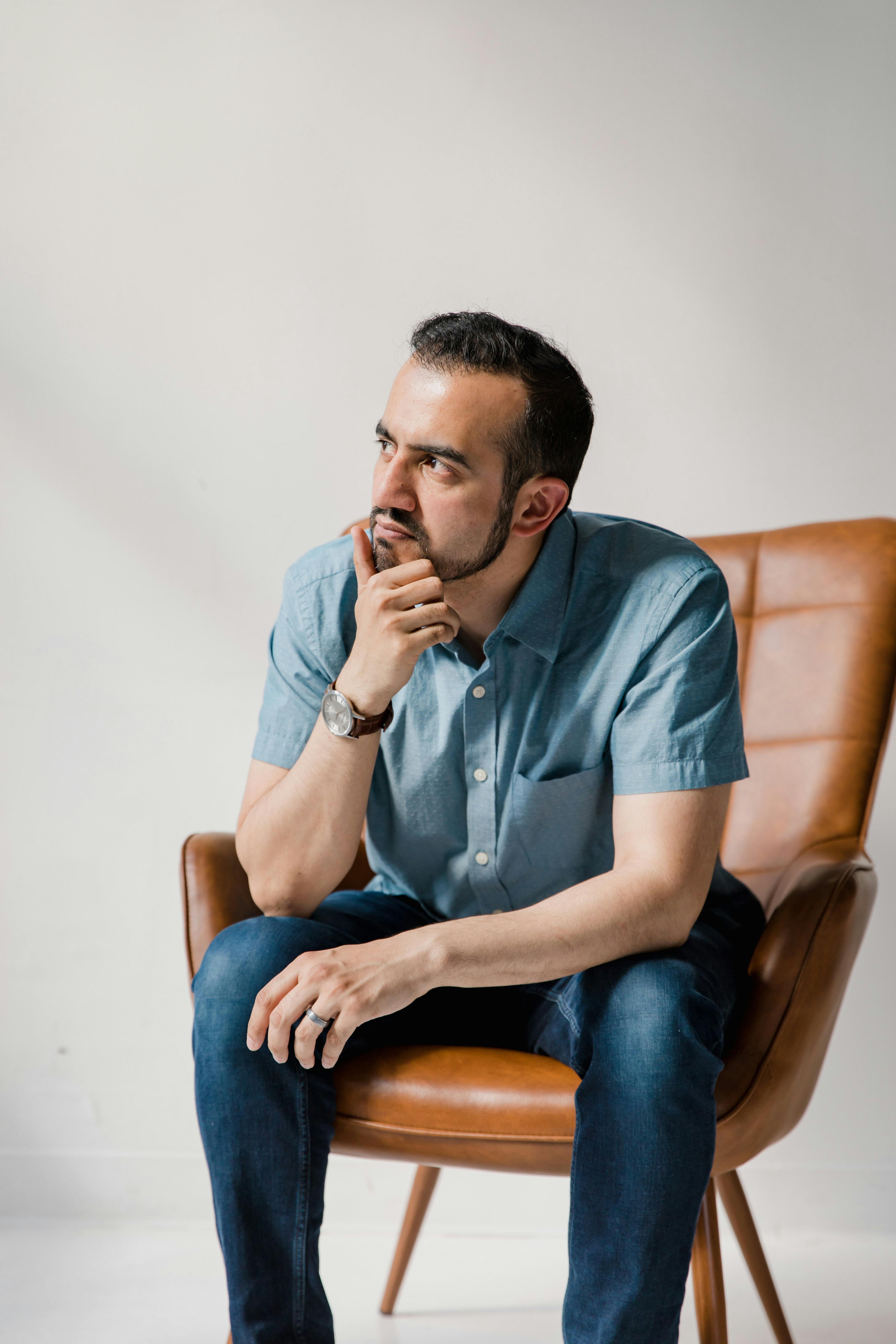 Man Seating on Concrete Base · Free Stock Photo