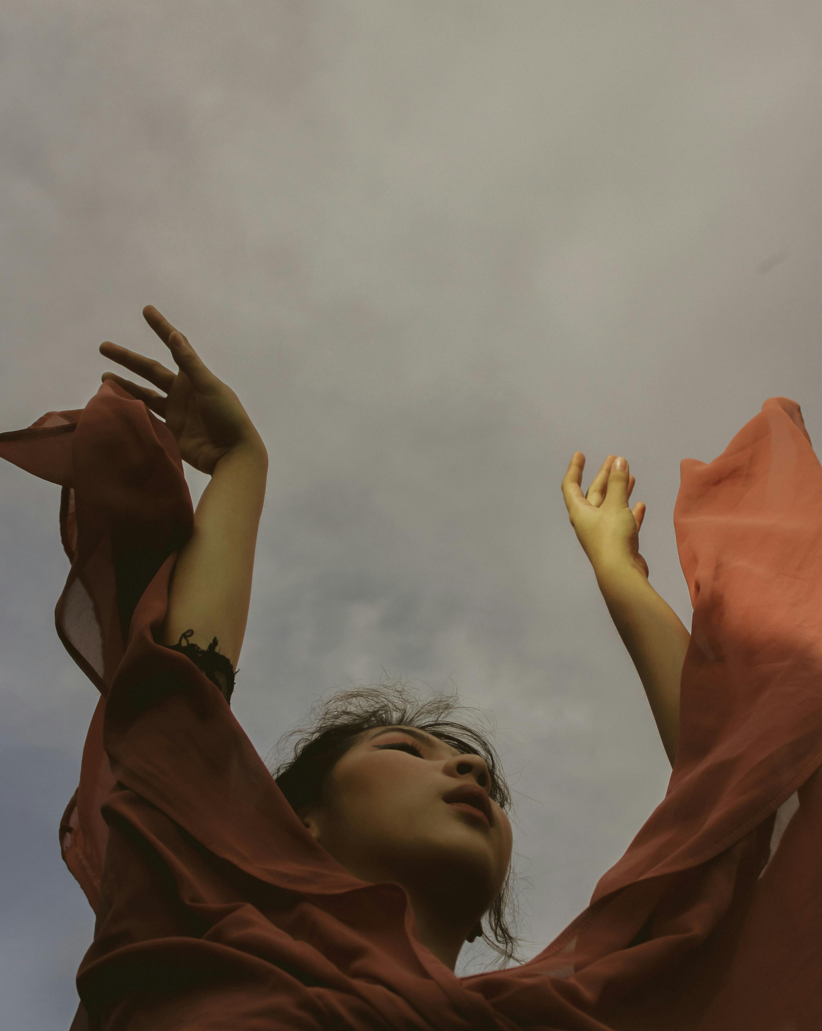 Back View of a Woman Raising Her Arms · Free Stock Photo