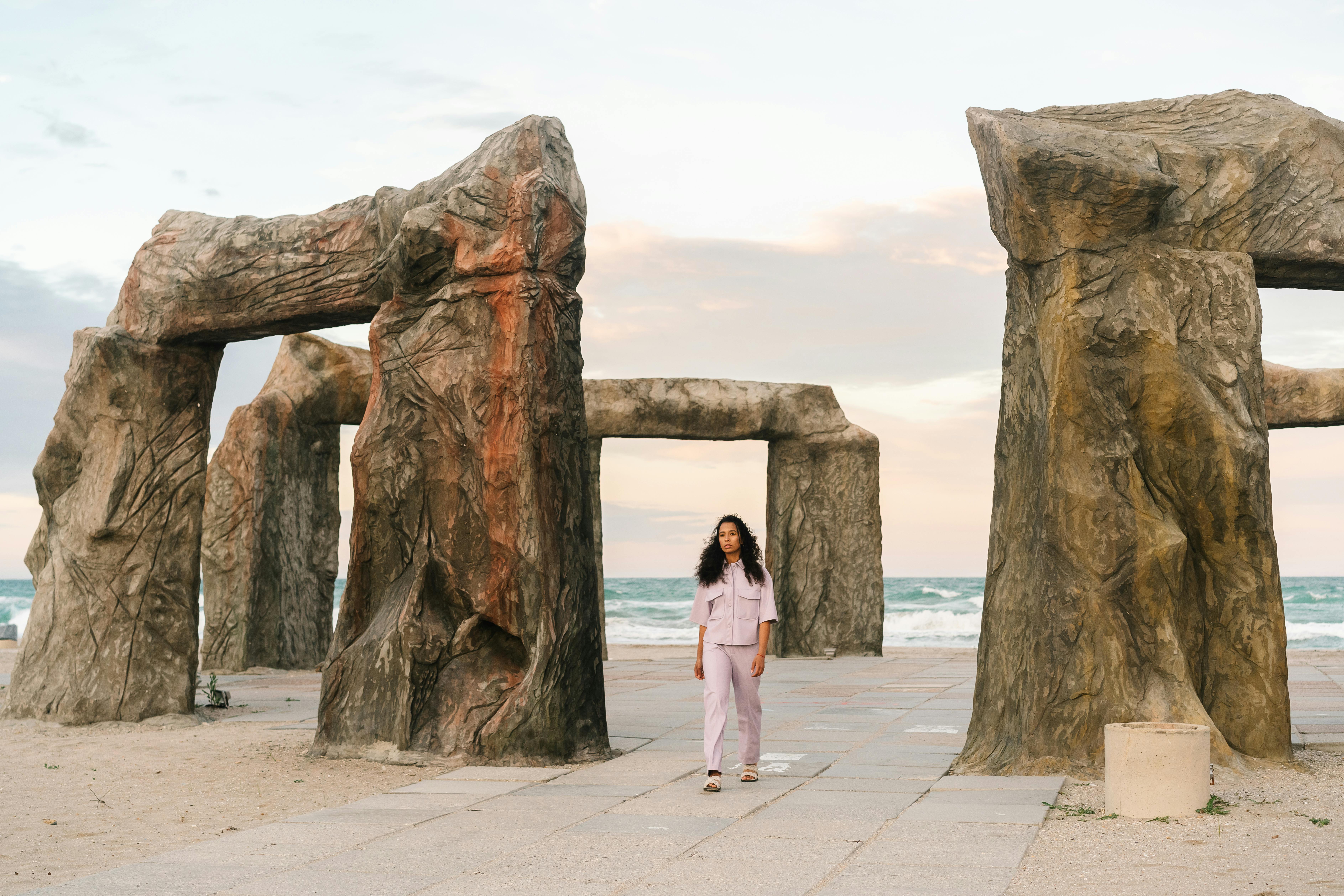 A Woman Walking by Sculptures at Z City Beach · Free Stock Photo